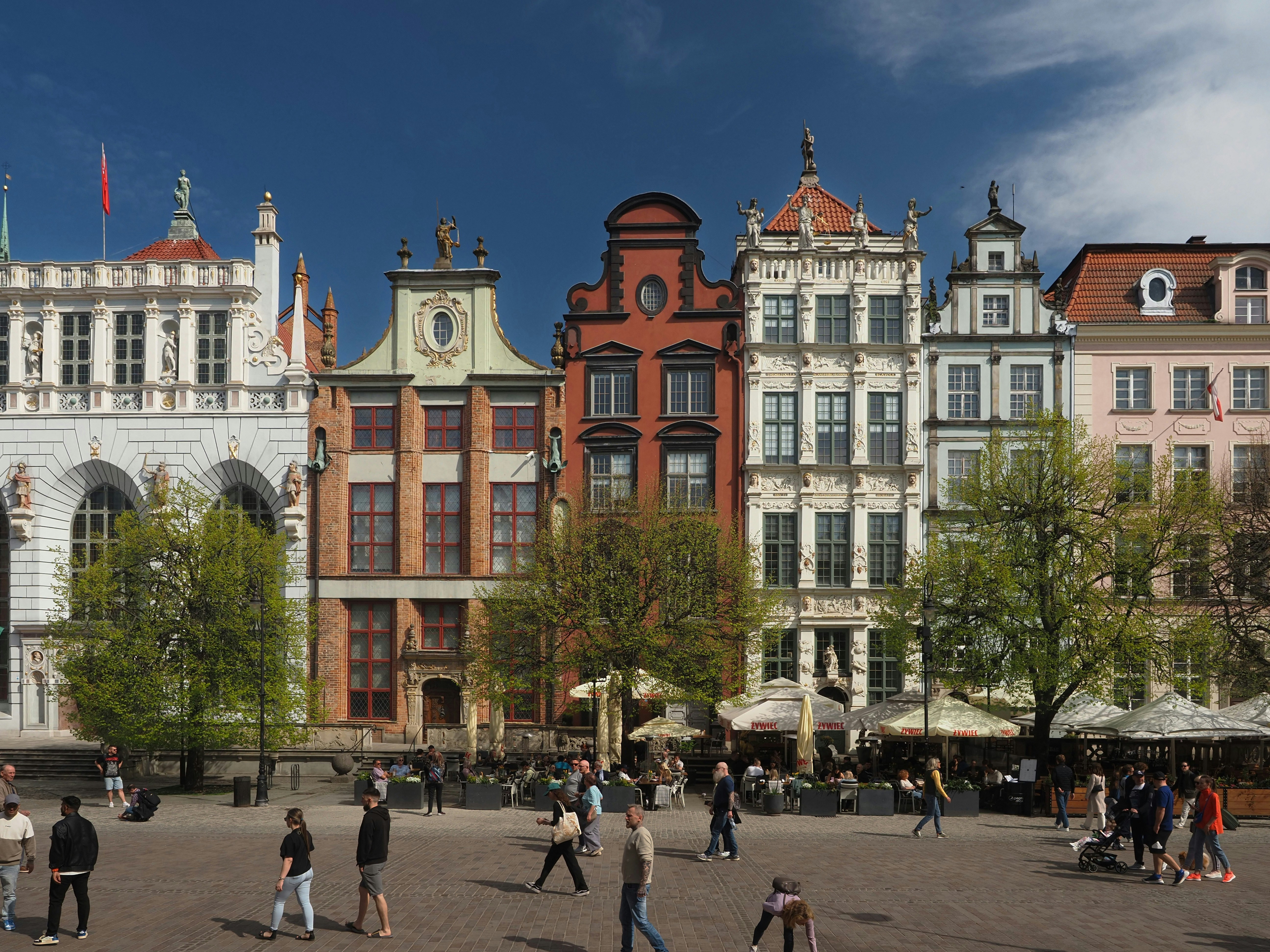 Beautiful colorful buildings line a city square. photo – Free Building ...