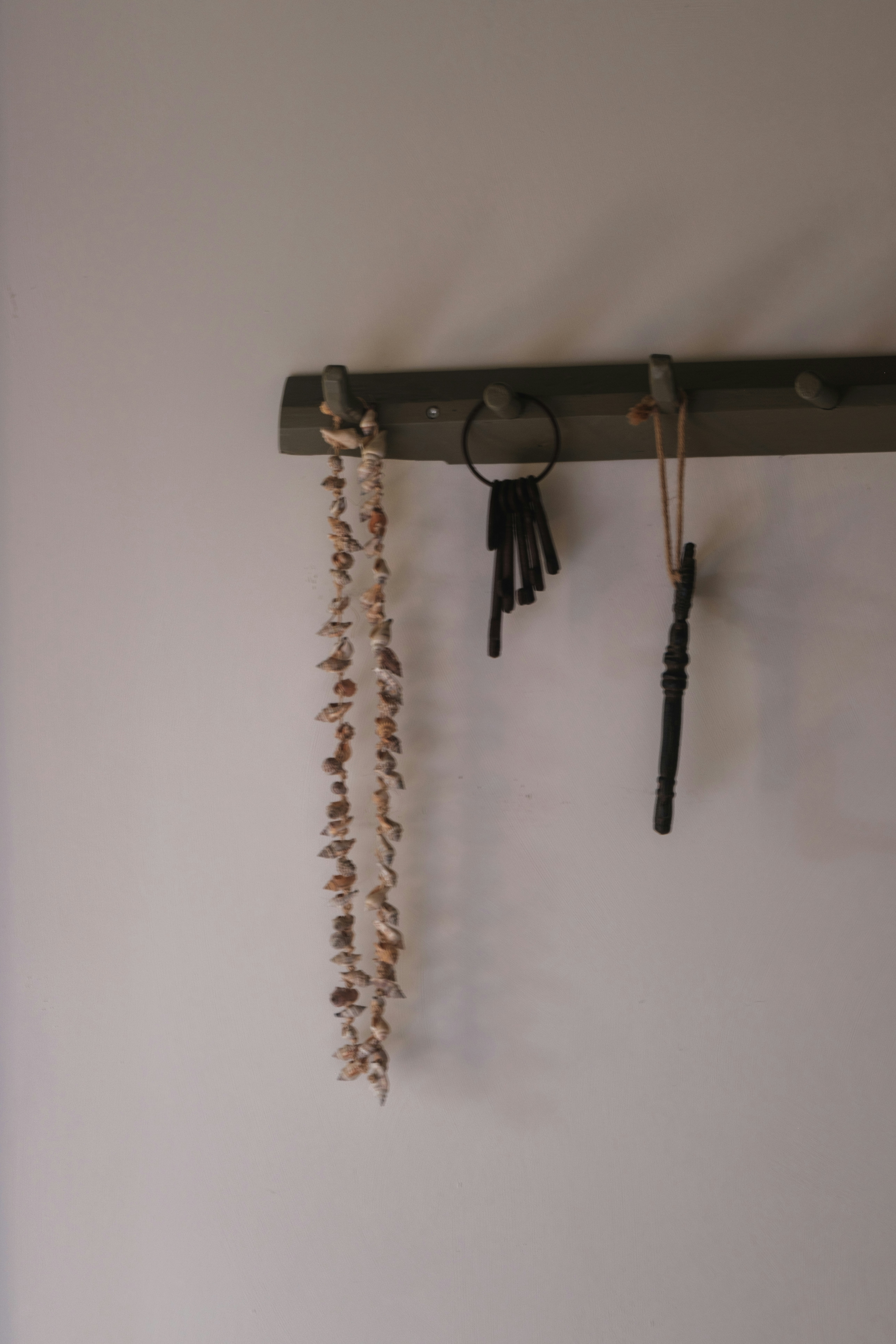 Necklace, keys, and other items hanging on a rack. photo – Free ...