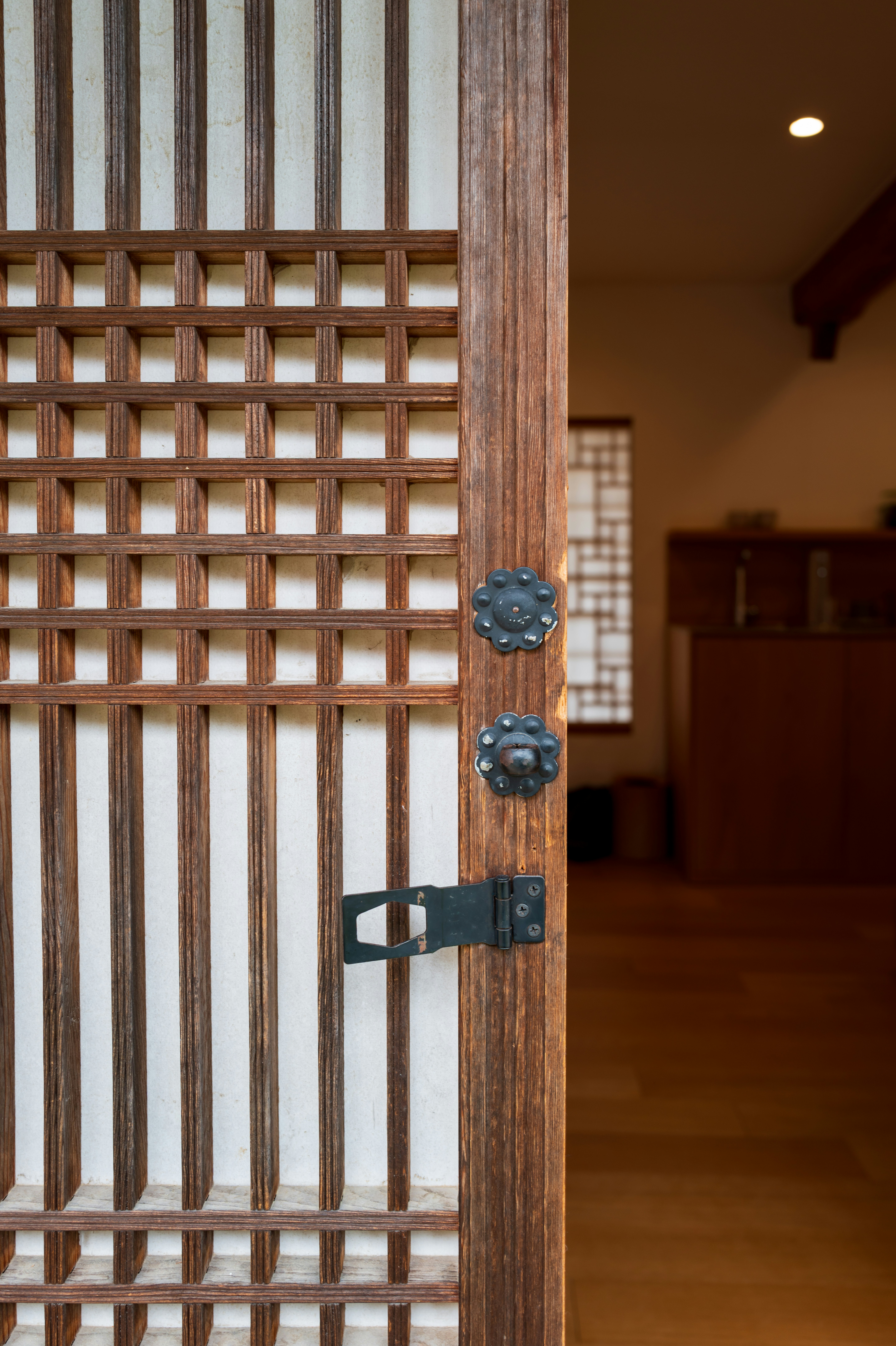 A partially open, traditional korean wooden door