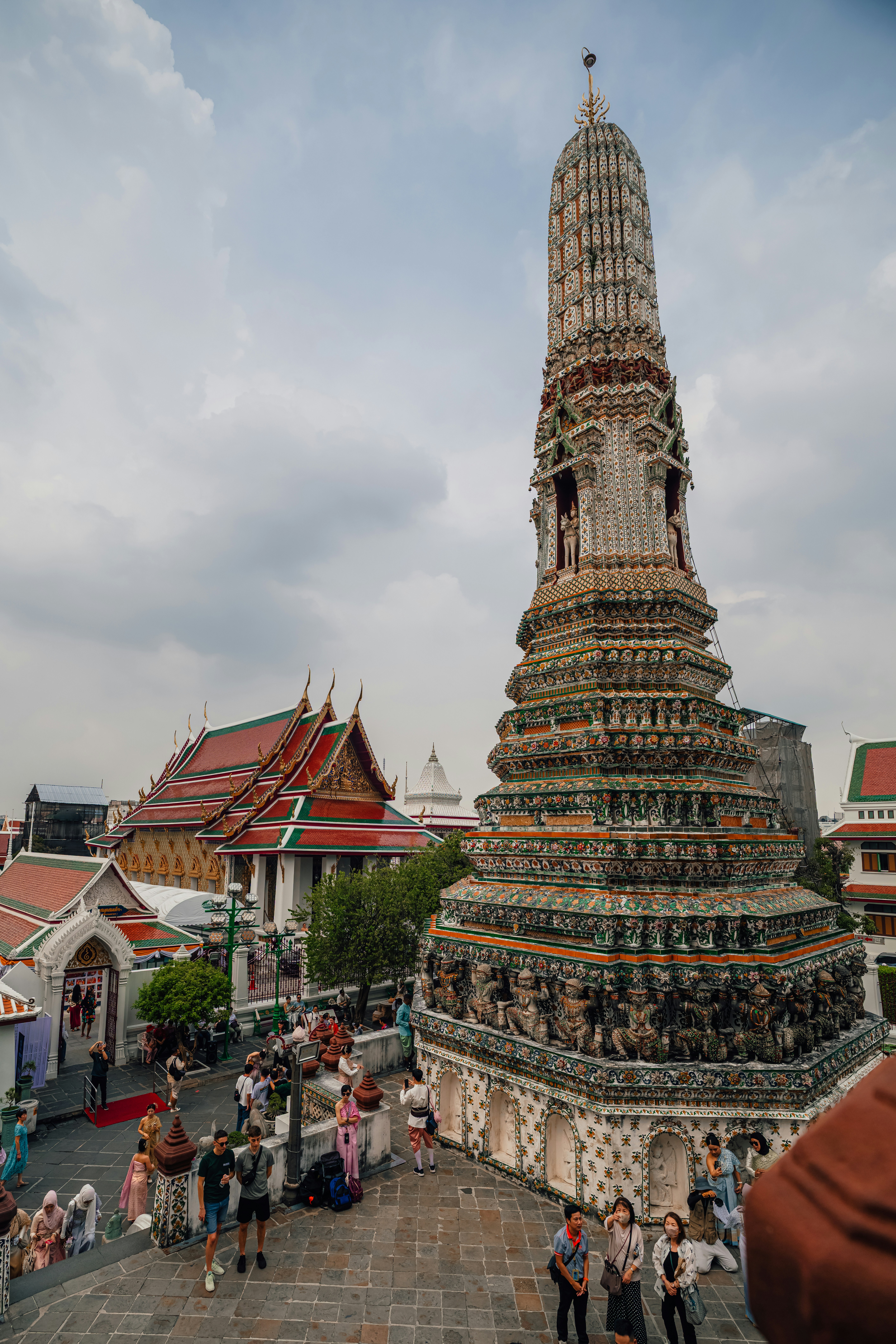 The Mosaic Prang: Wat Arun's Spire Reigning Over Bangkok's Temple Courtyard