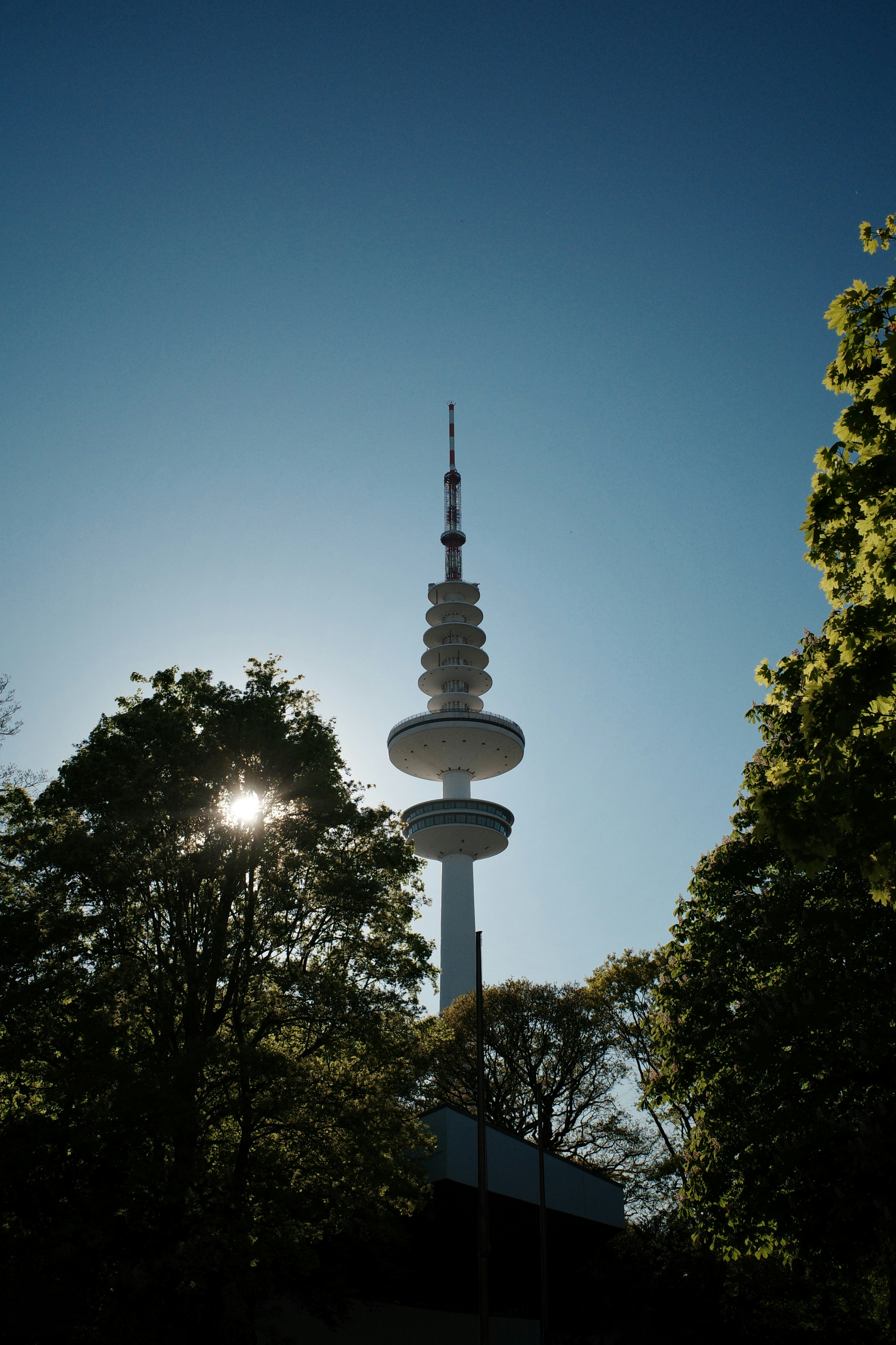A tower rises against a bright blue sky. photo – Free Architecture ...