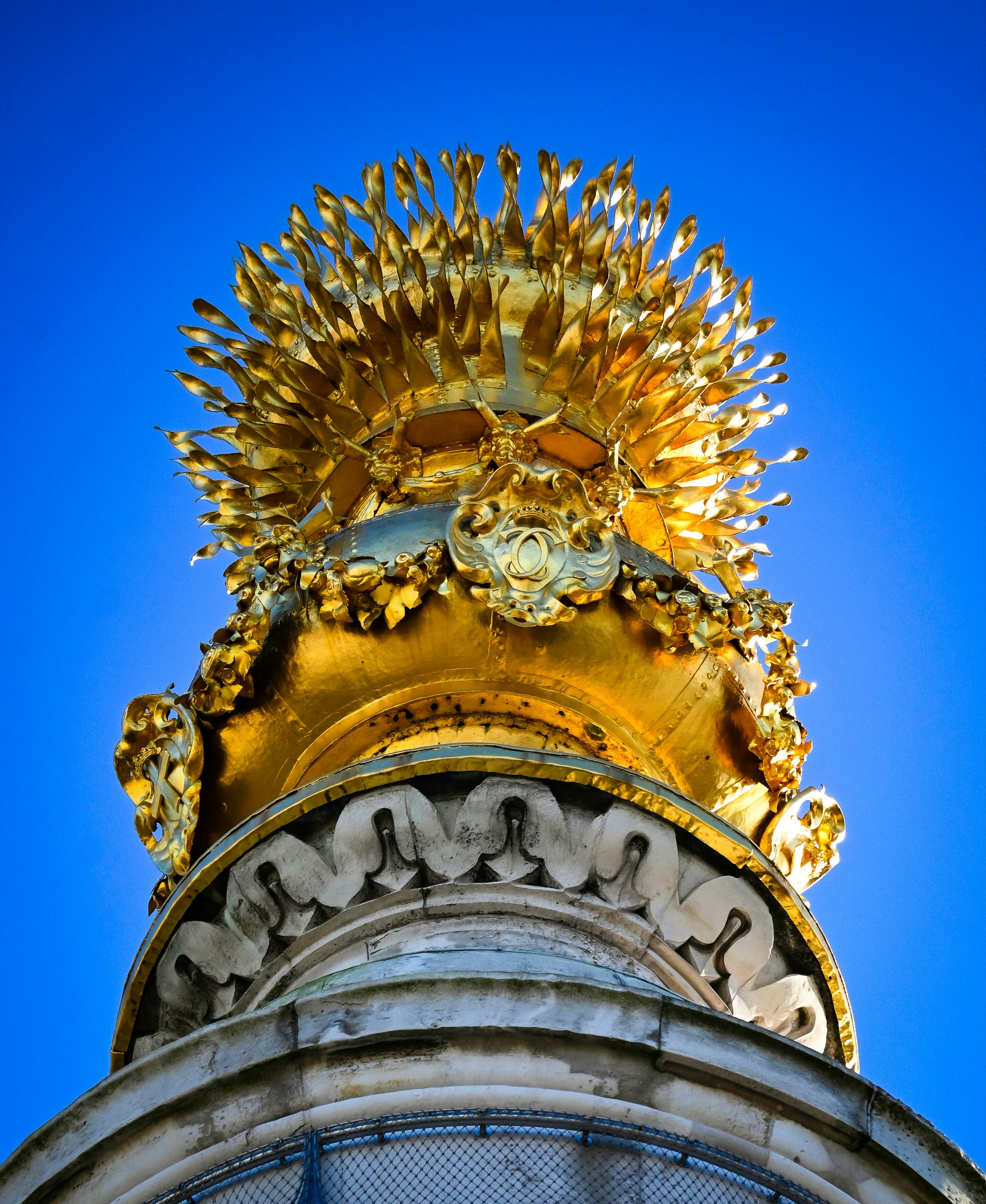 Sunburst Crown Above the Blue: a close-up of a gilded spire