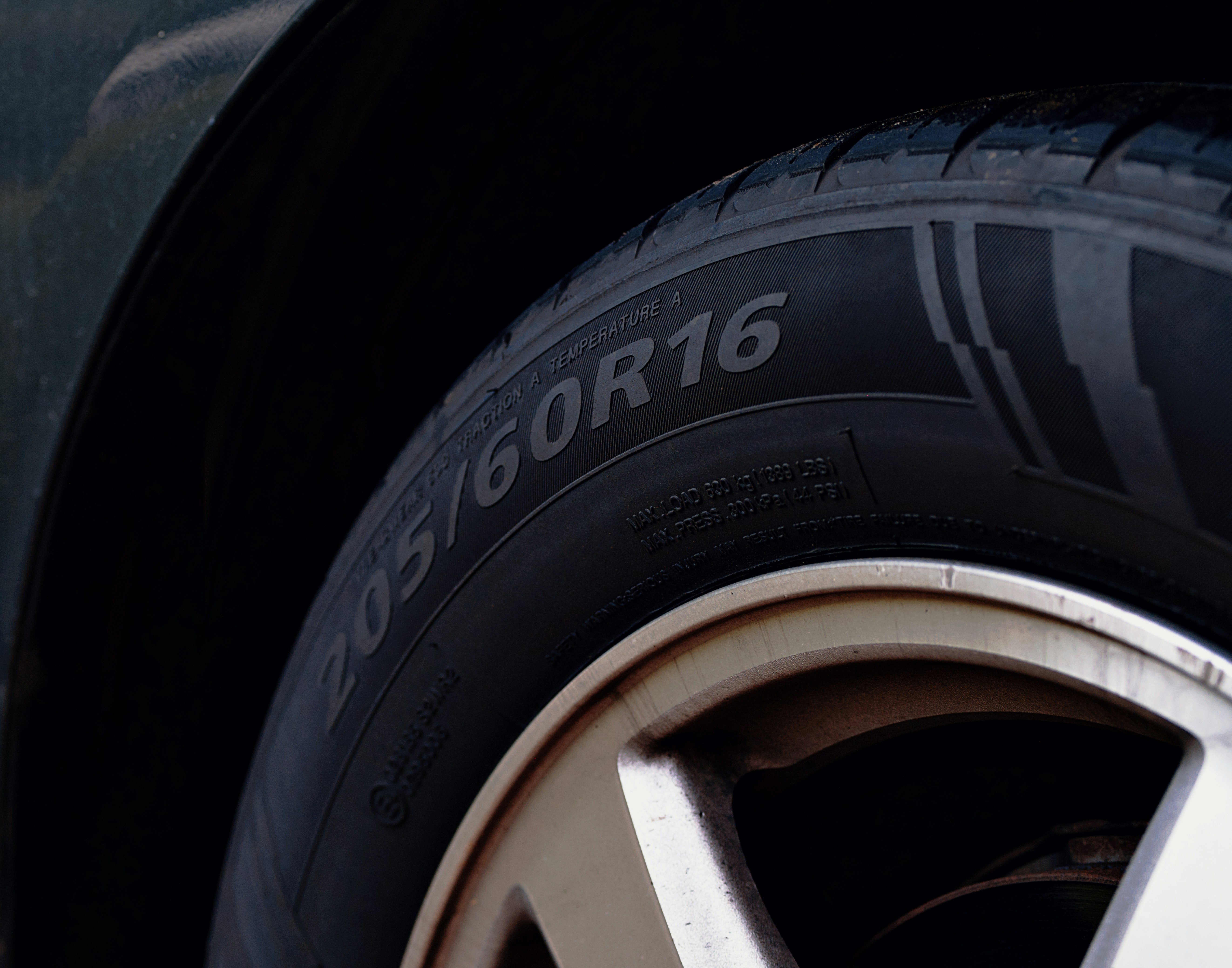 Tire Glyphs in Macro: Weathered Markings Meet Cast Aluminum