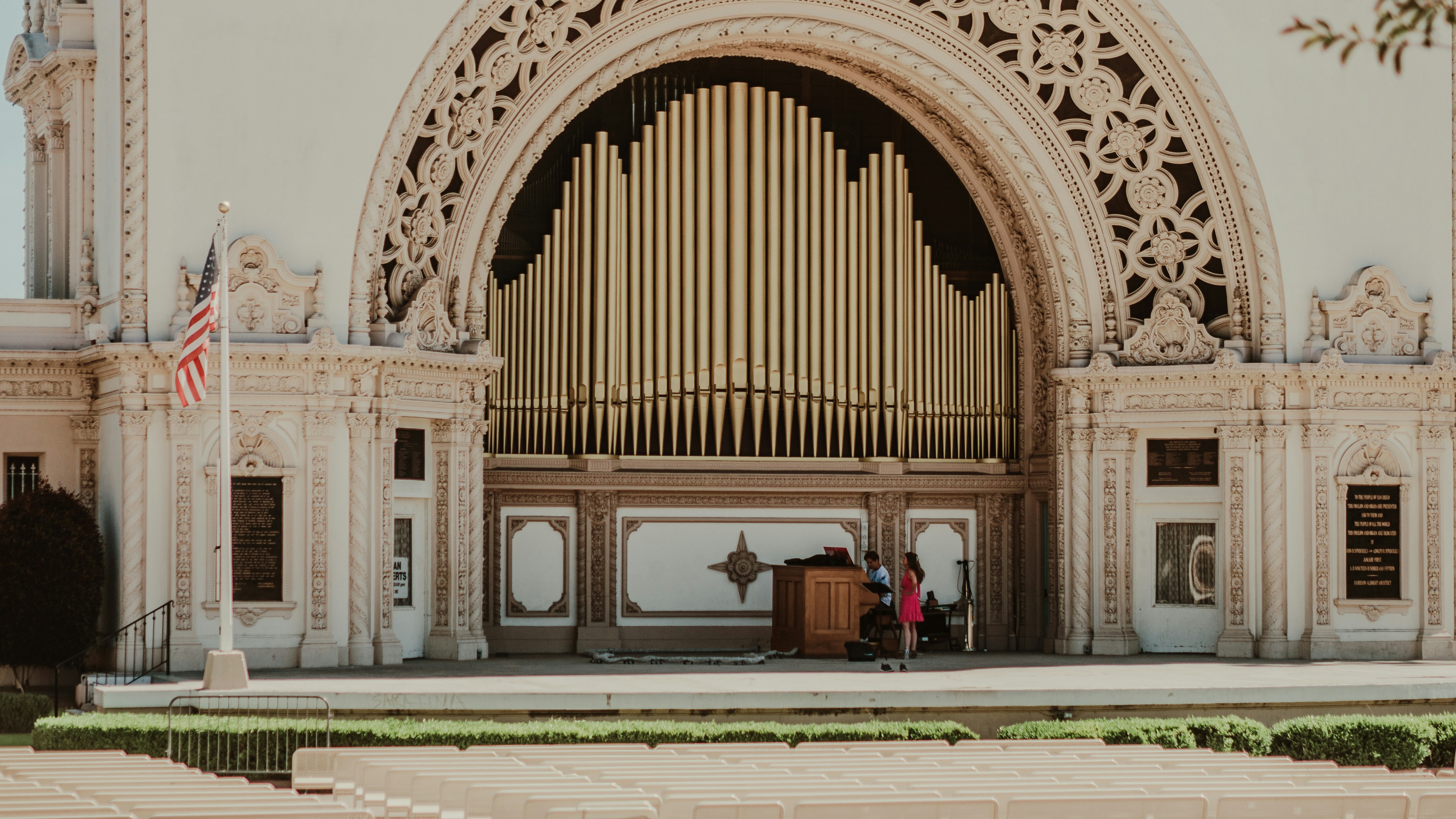 A magnificent organ resides within an ornate building.