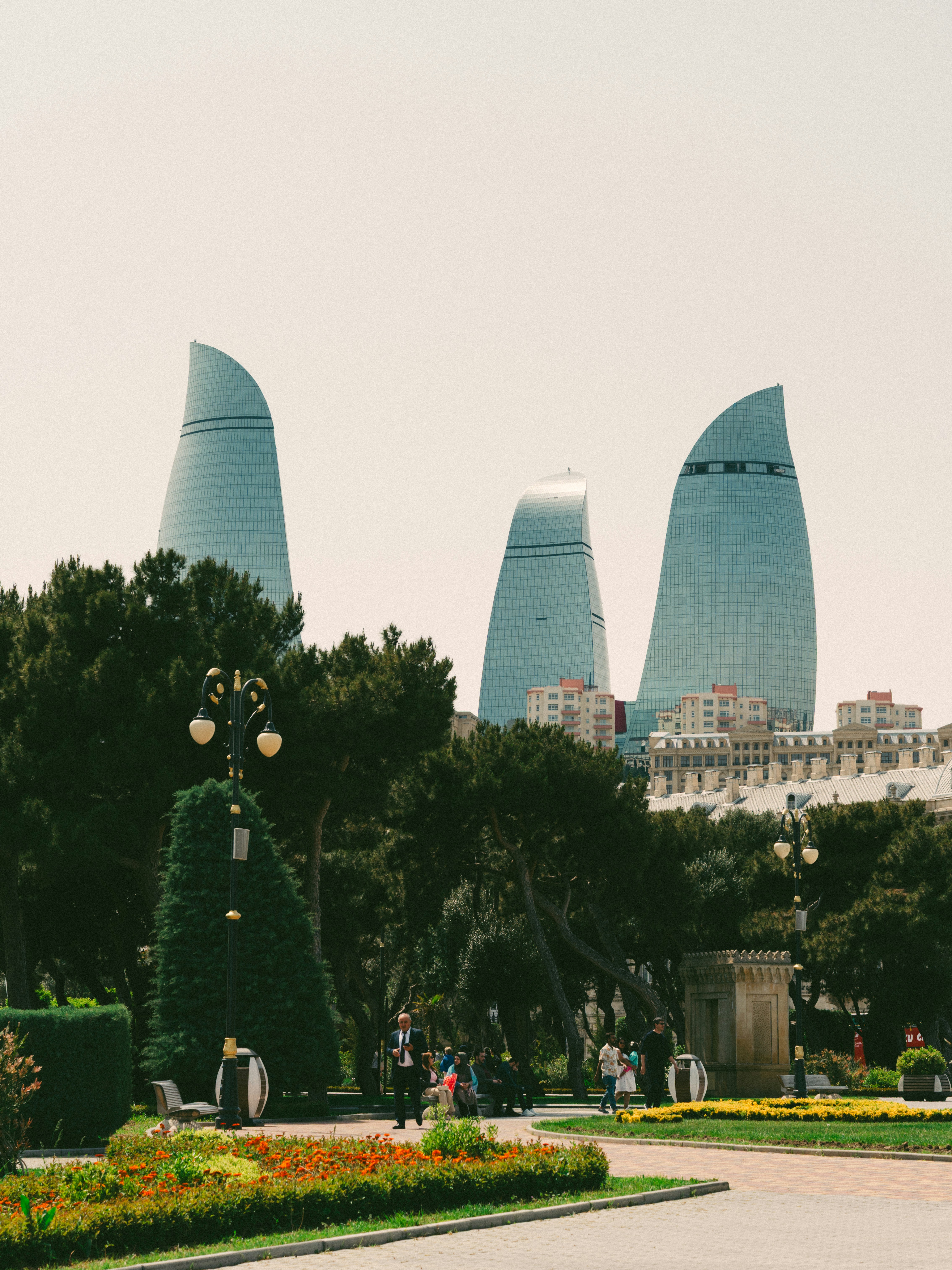 The flame towers rise above the city park. photo – Free Building Image ...