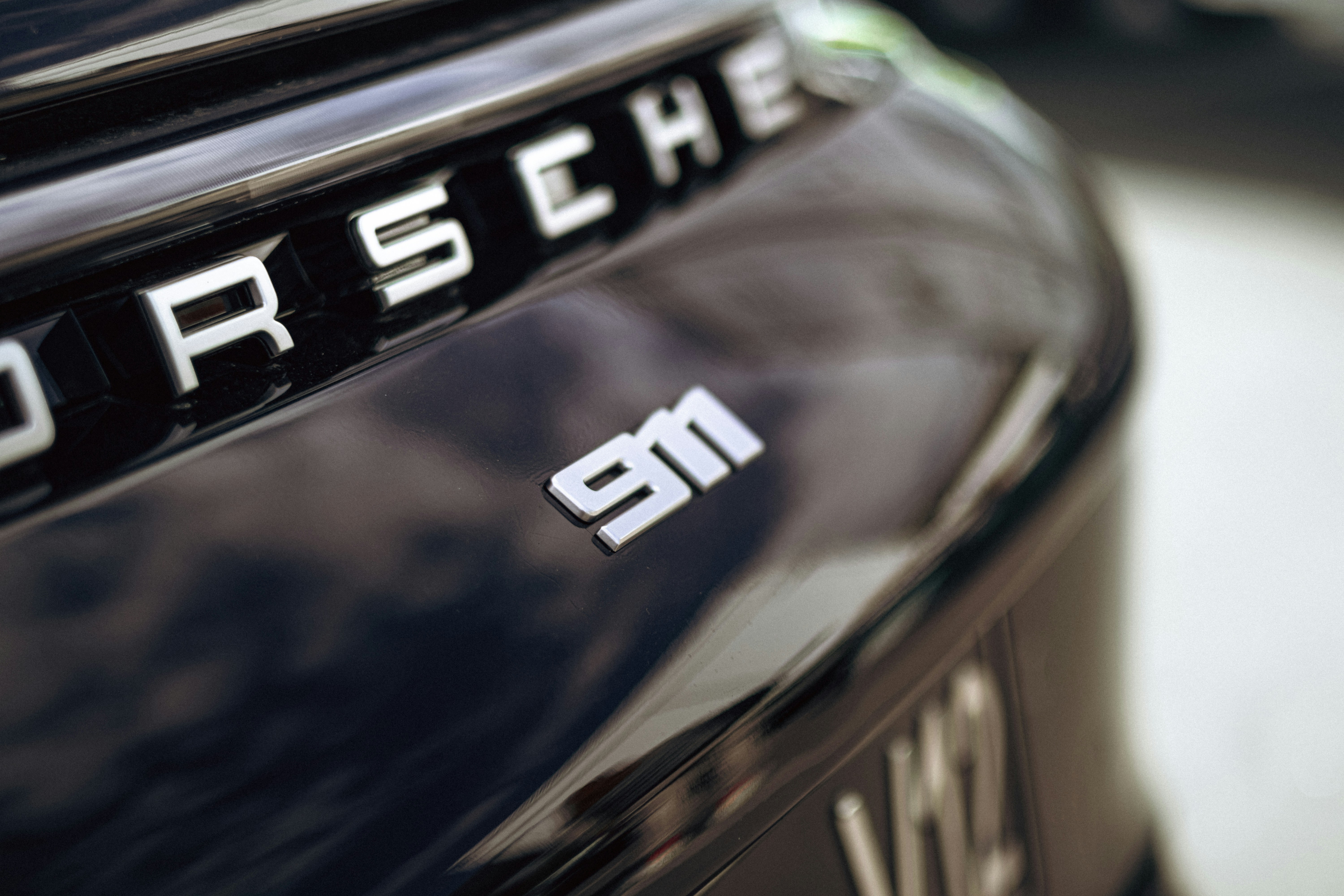 Emblem in Focus: Porsche Crest on Ebony Curves