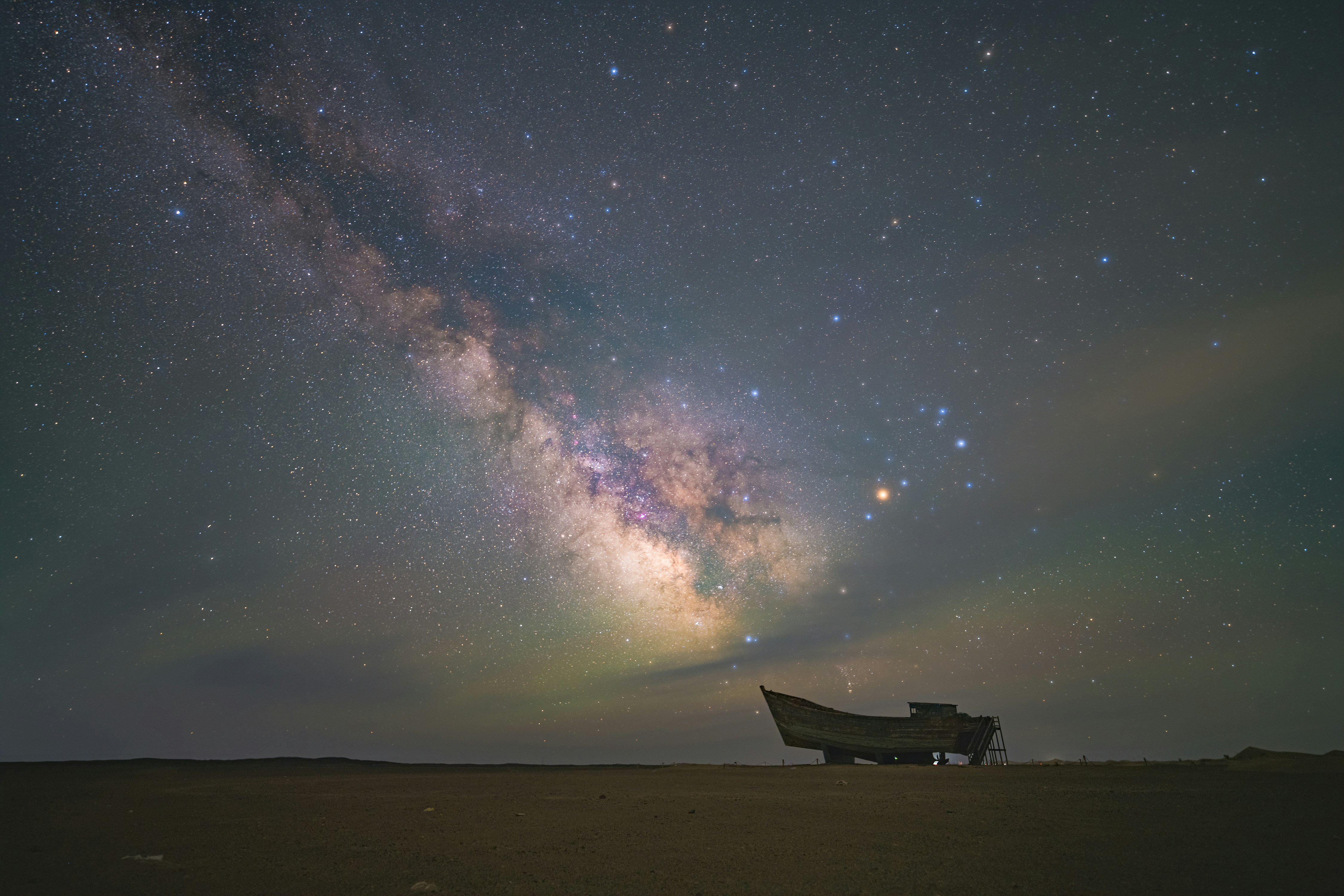 Milky way shines above an old, weathered boat. photo – Free Night sky ...