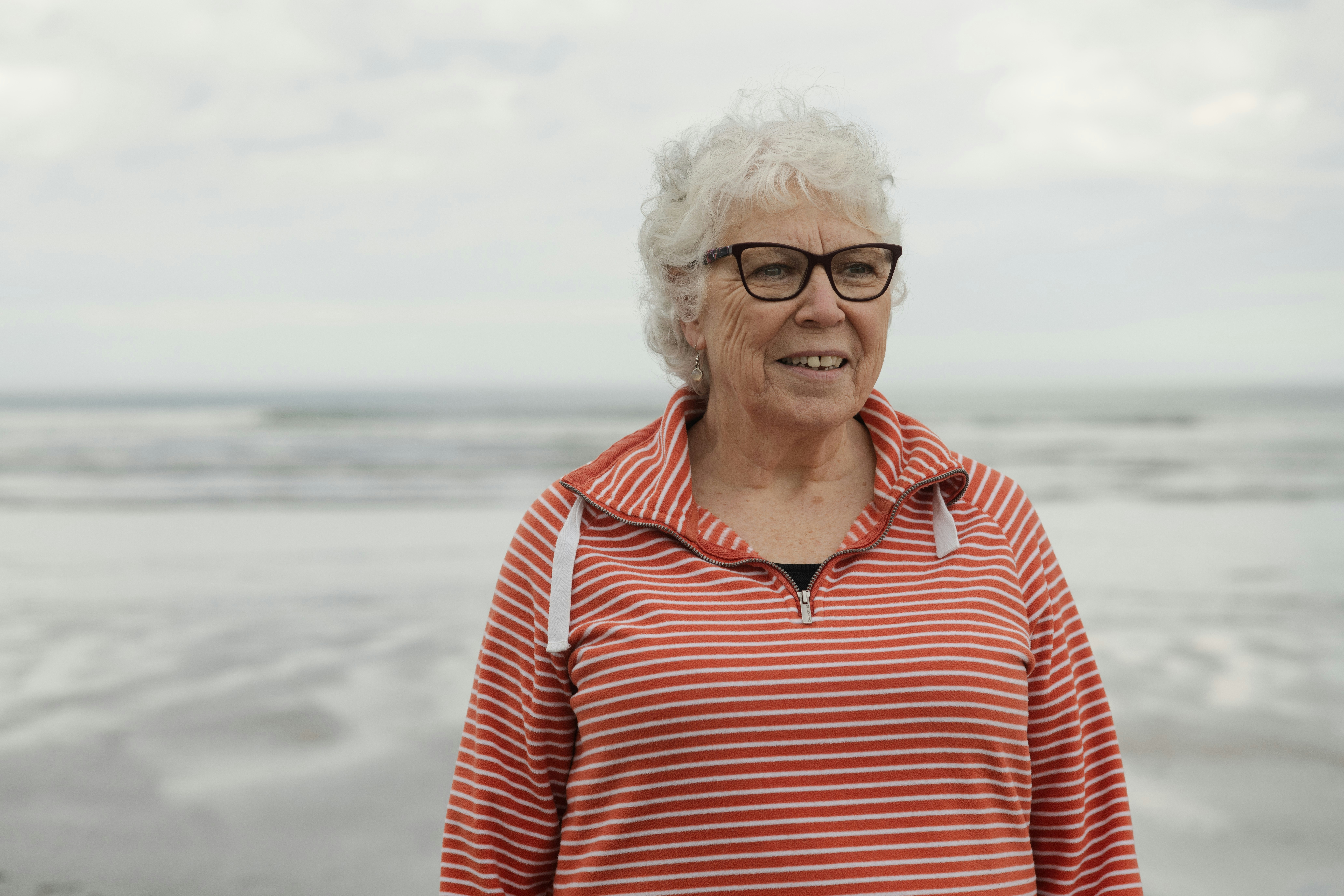 Windward Portrait on a Wind-Swept Beach in a Red Stripe Hoodie