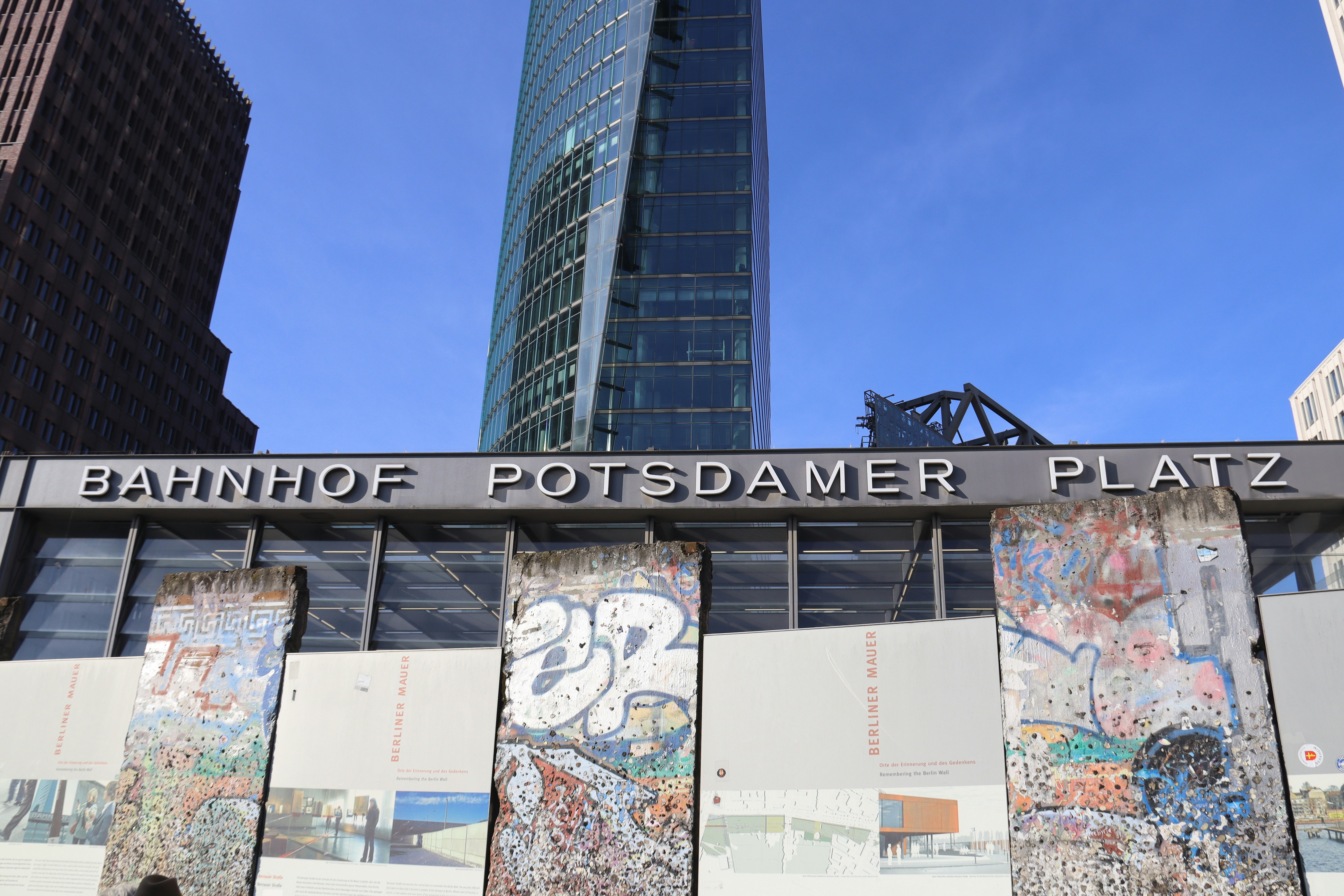 Potsdamer Platz: Graffiti Panels Framing a Skyward Glass Tower