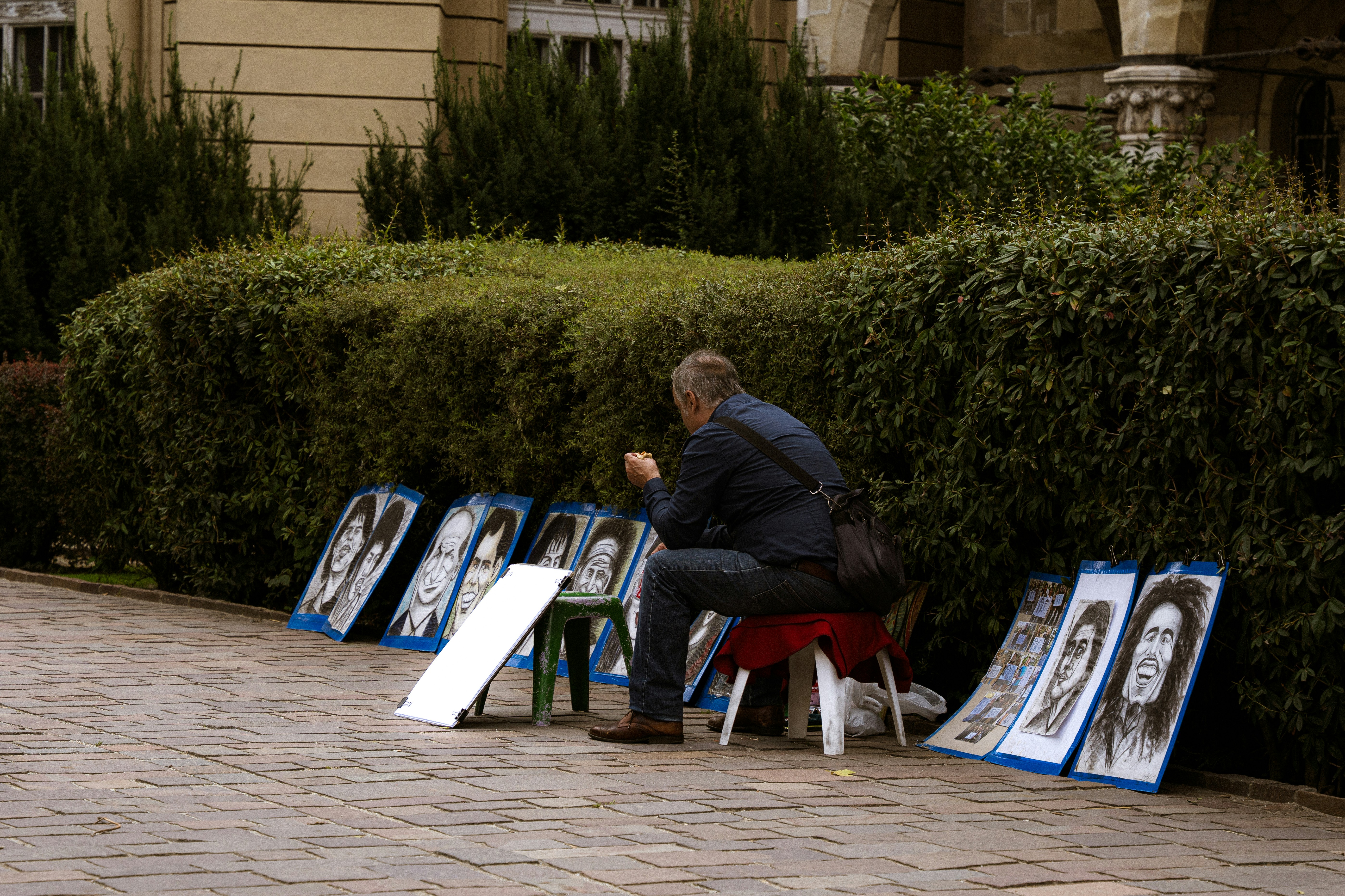An artist displays portraits on an outdoor setting. photo – Free Travel ...