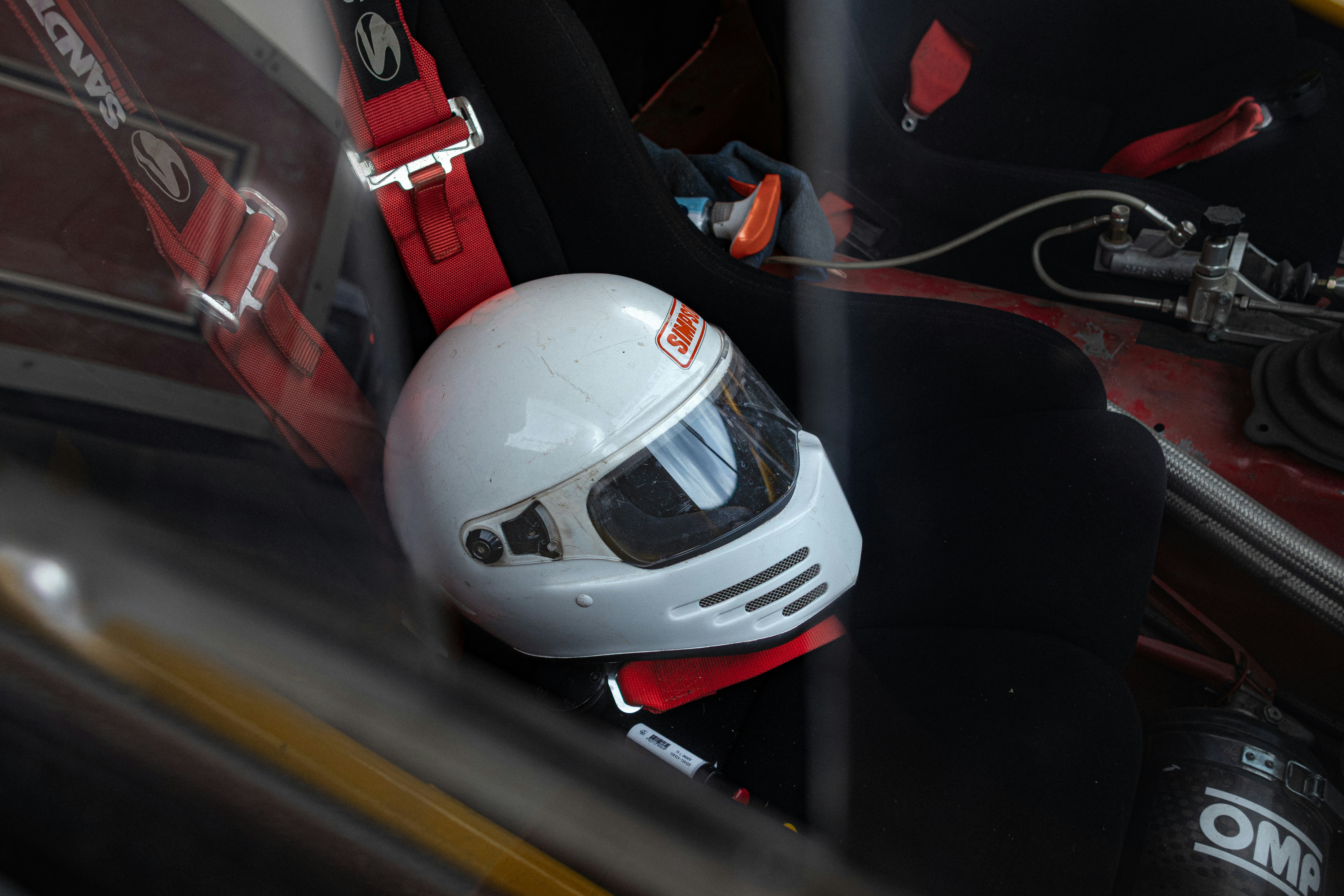 White Racing Helmet in a Crimson Cockpit: A Close-Up Study