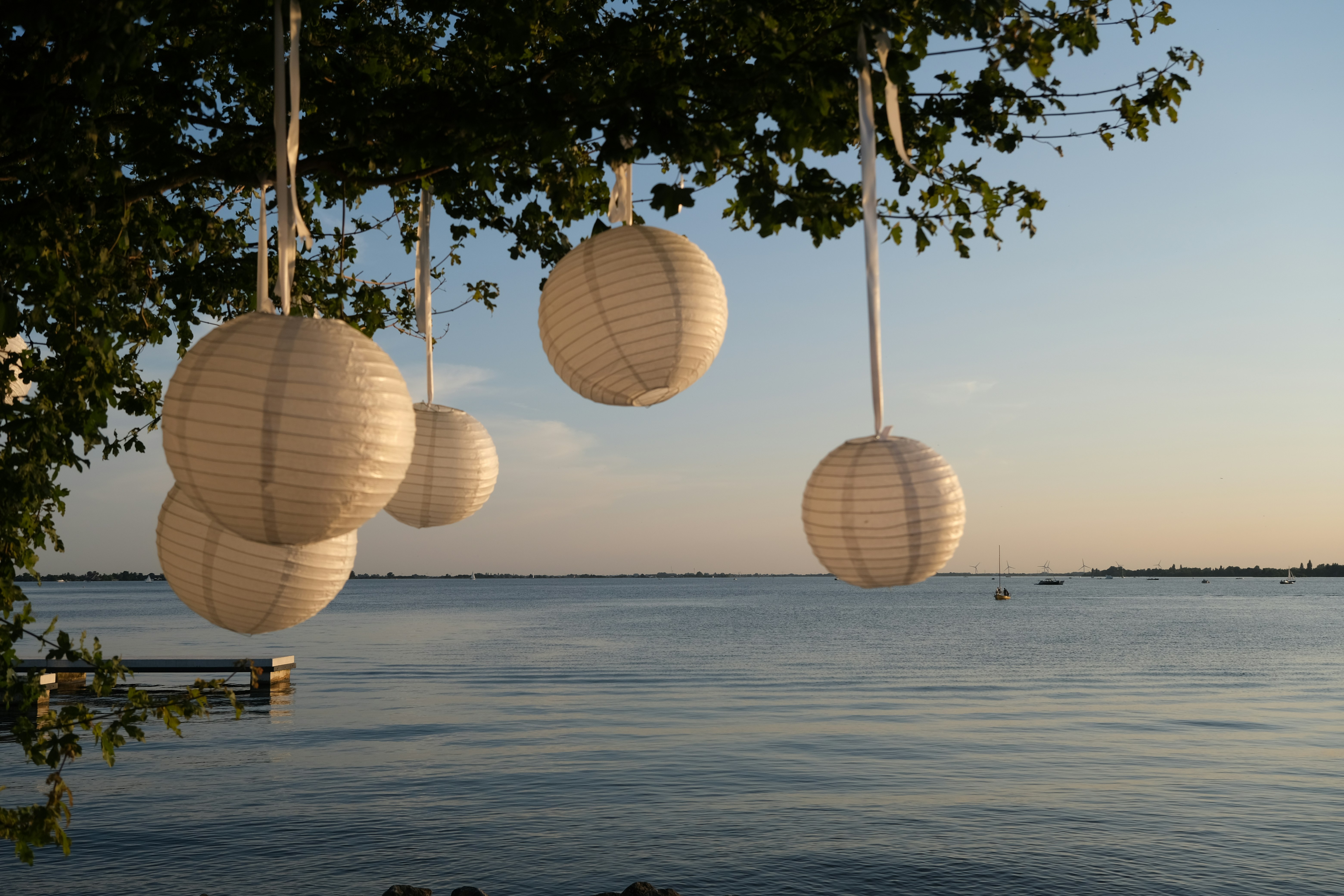 Floating Lanterns Over a Calm Lake at Dusk