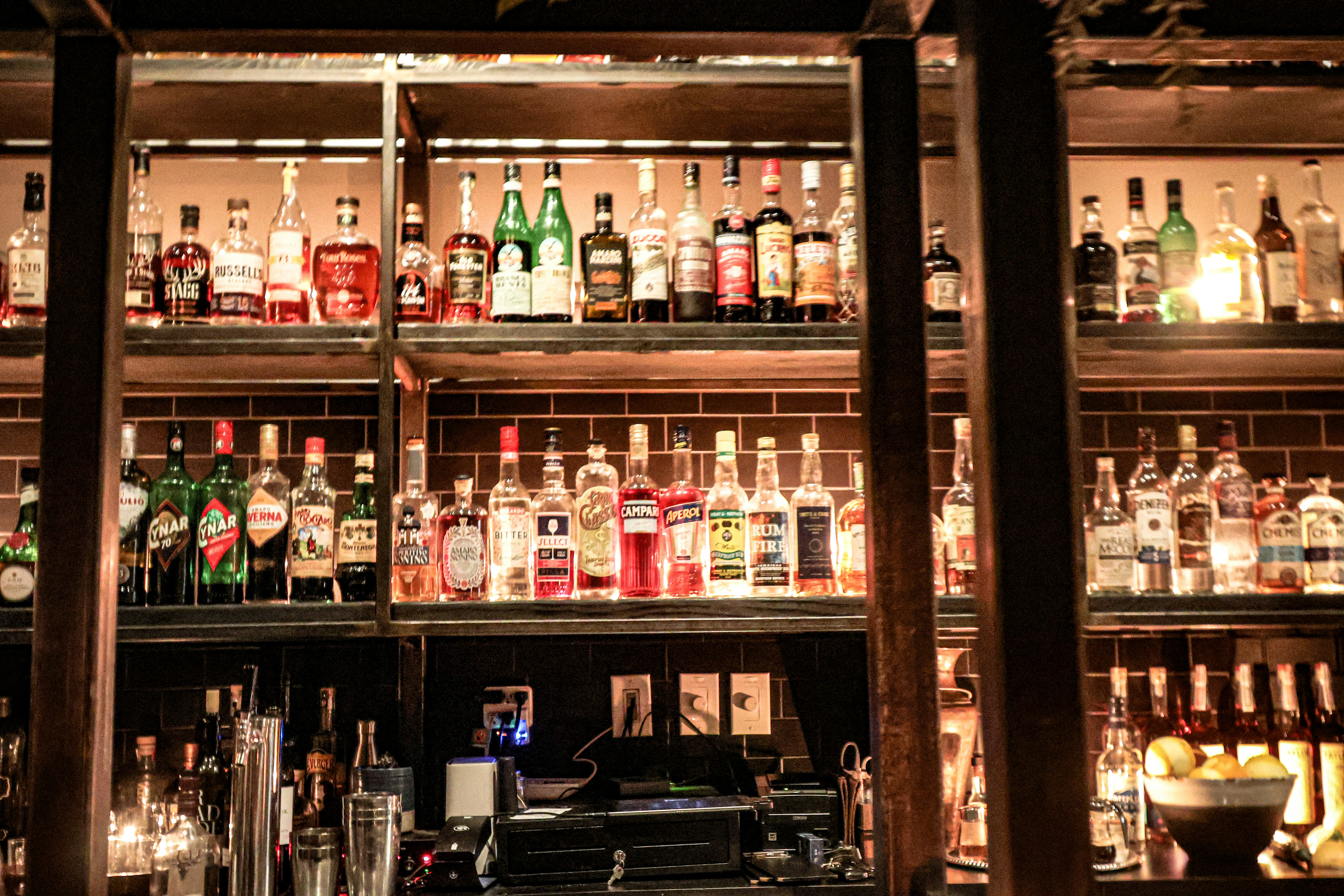 A bar displays rows of colorful alcohol bottles. photo – Free Bar Image ...