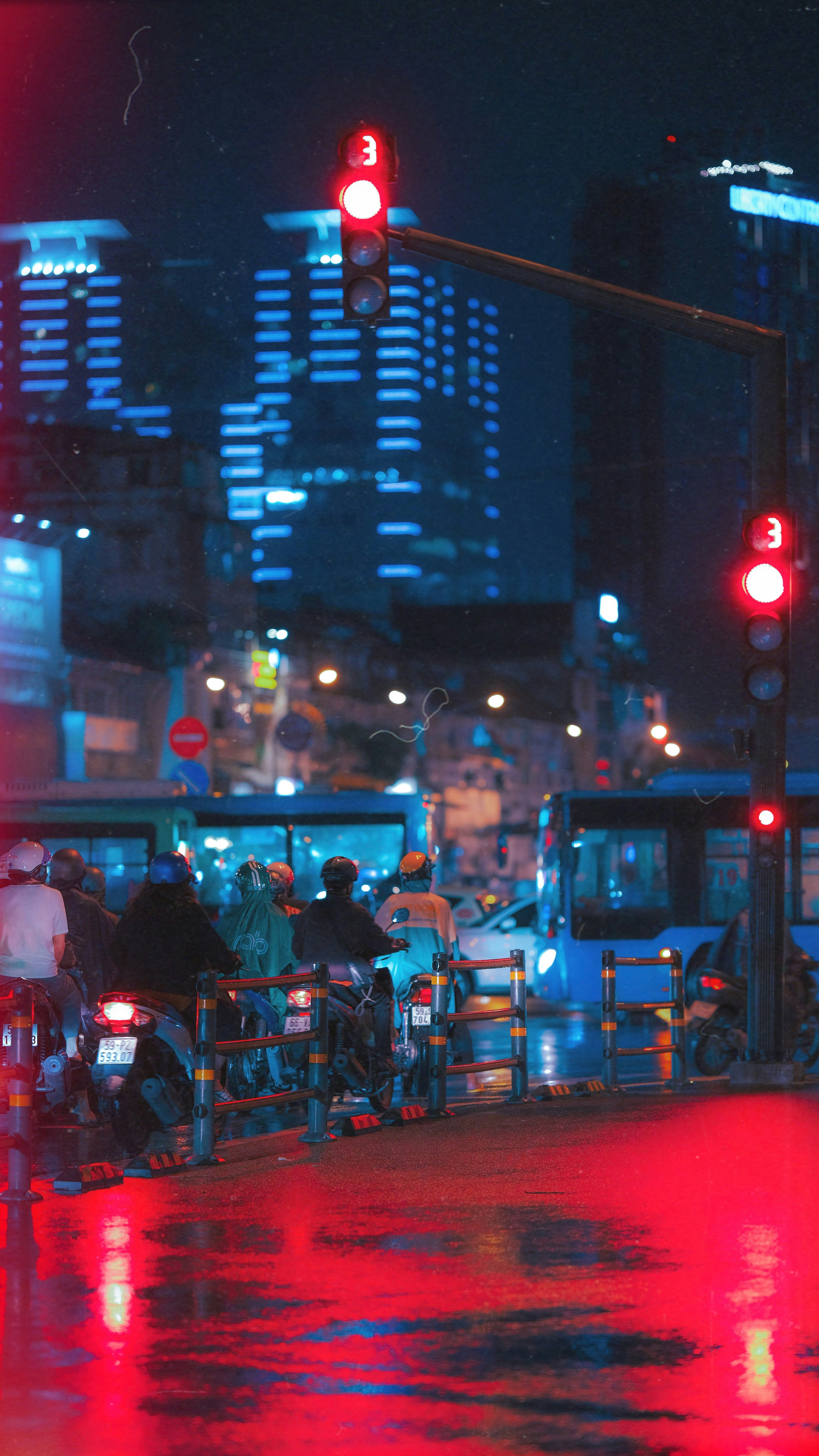 Nighttime city scene with illuminated buildings and vehicles. photo ...