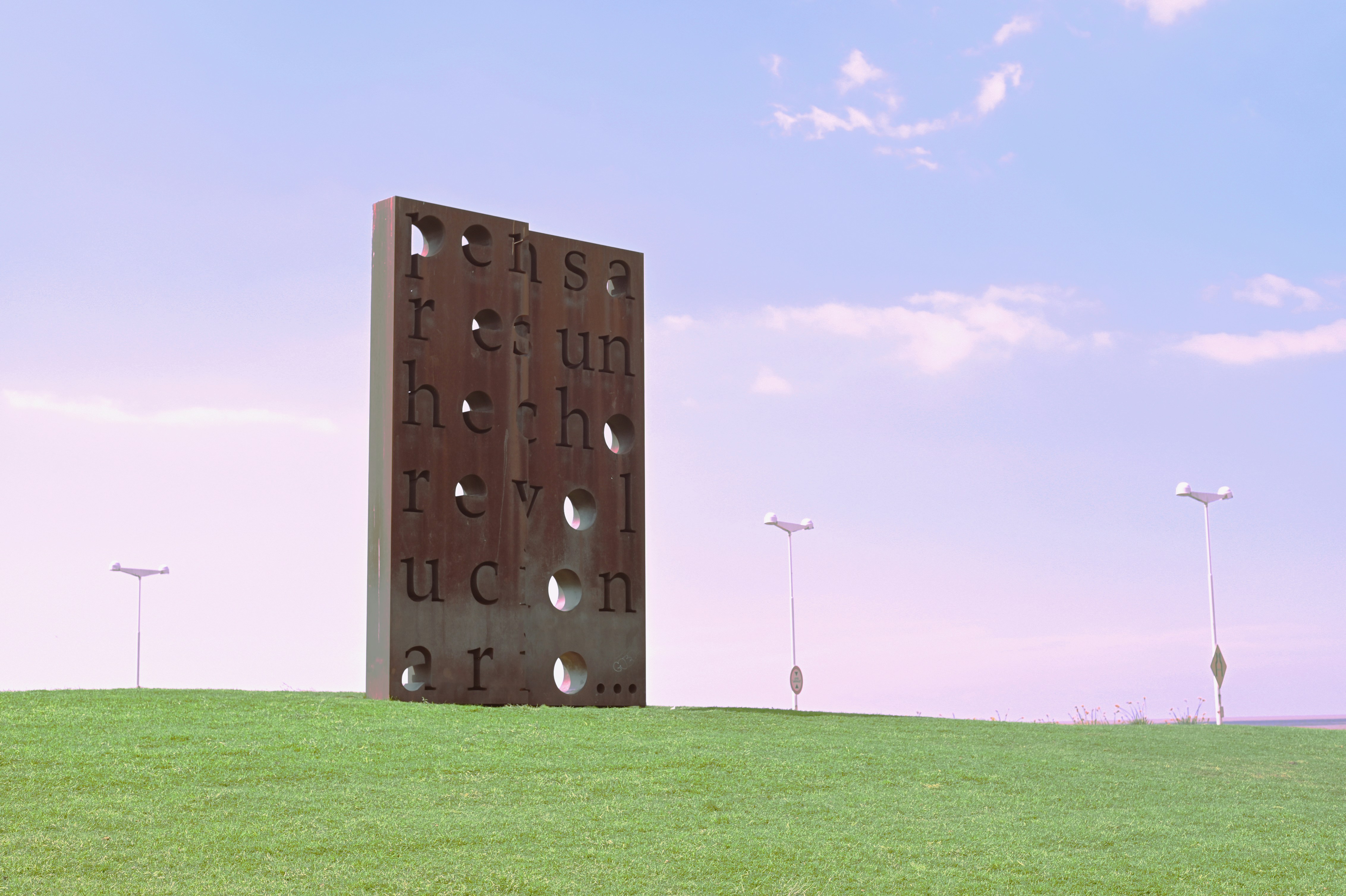 Glyphs on the Green: A Minimal Monument Under Pastel Skies