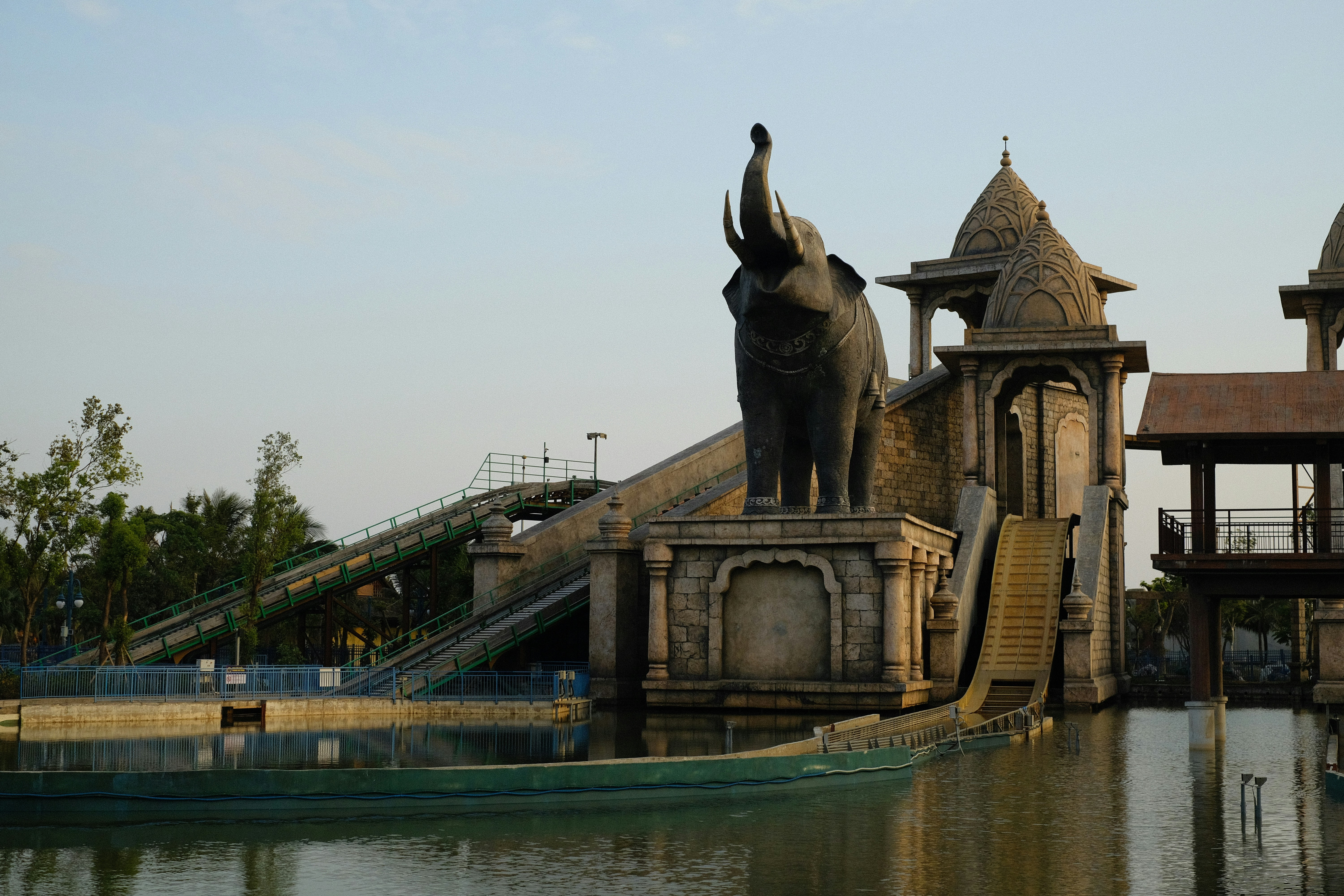 Stone-Elephant Sentinel Over a Sunlit Water Park
