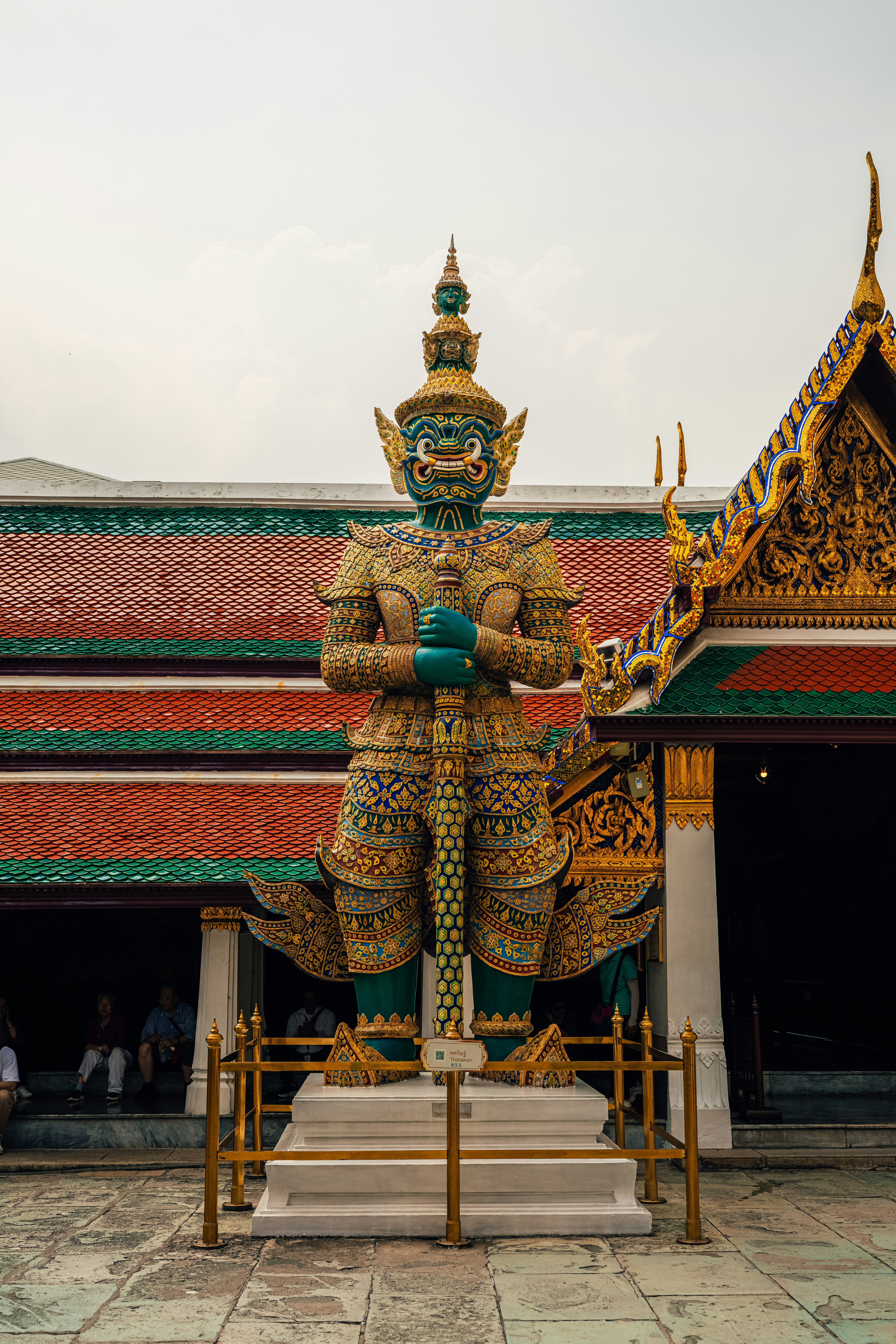 A giant statue stands guard at a temple.