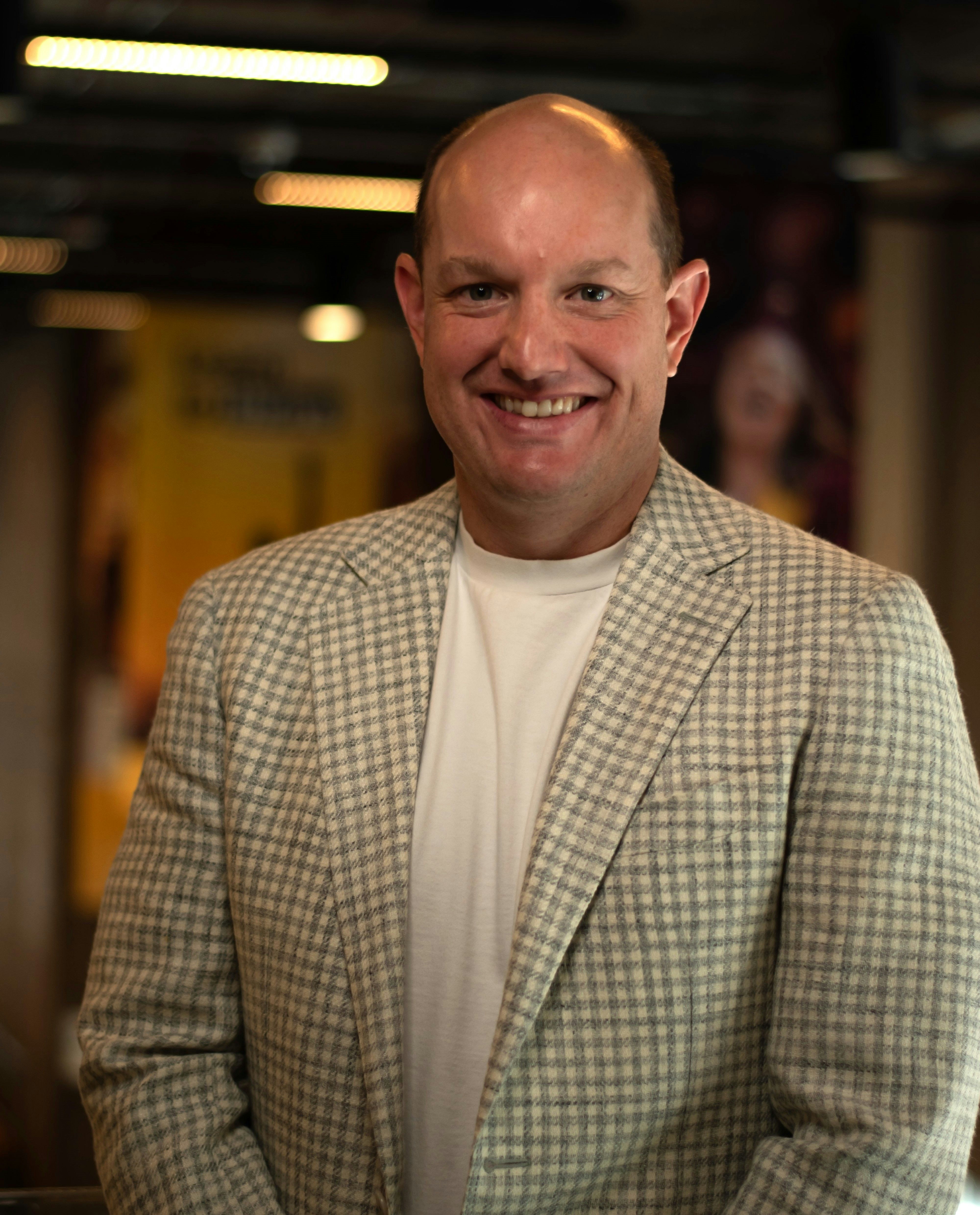 A man smiles while wearing a blazer. photo – Free Portrait Image on ...
