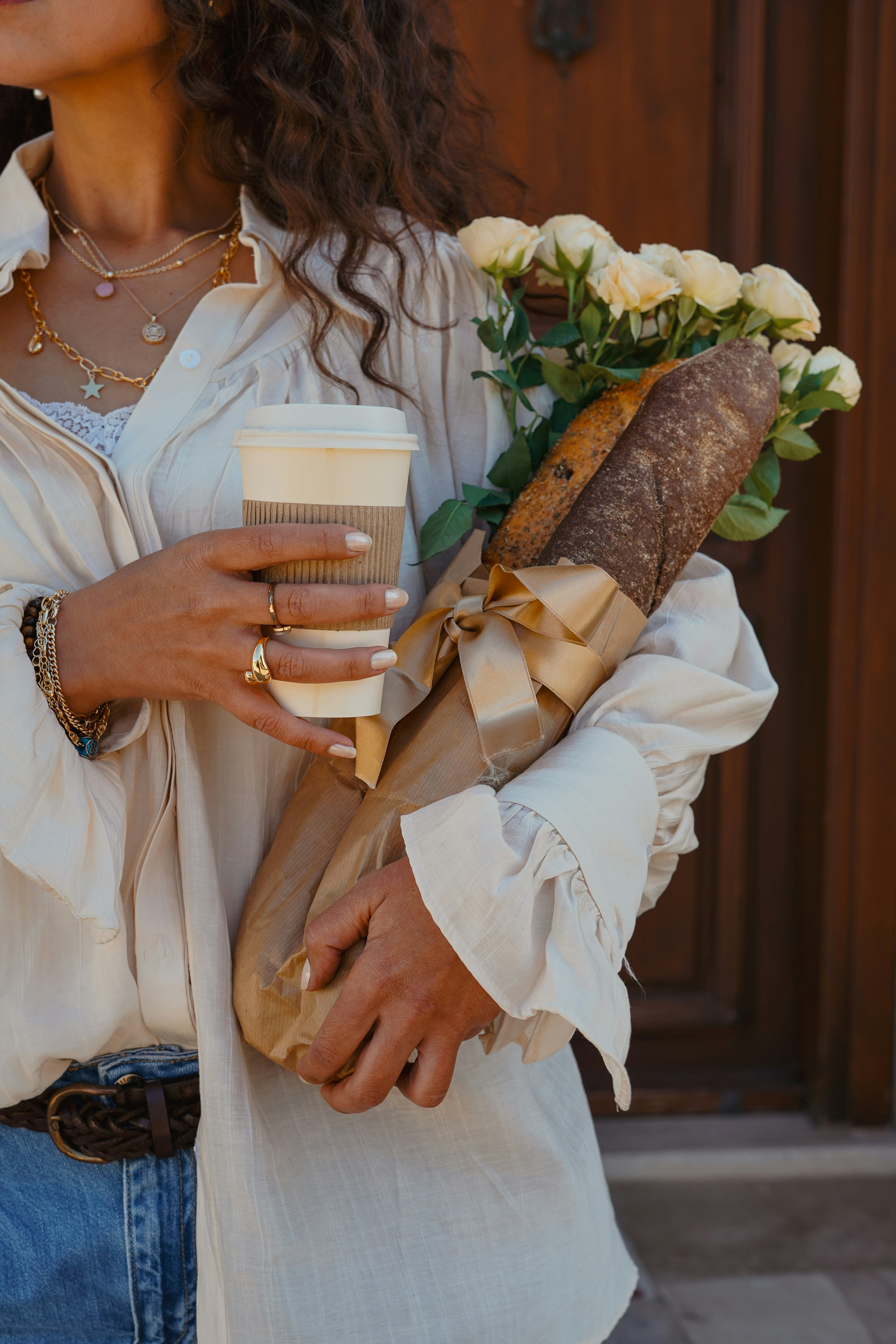 To-Go Ritual: Coffee Cup, Wrapped Baguette, and White Roses