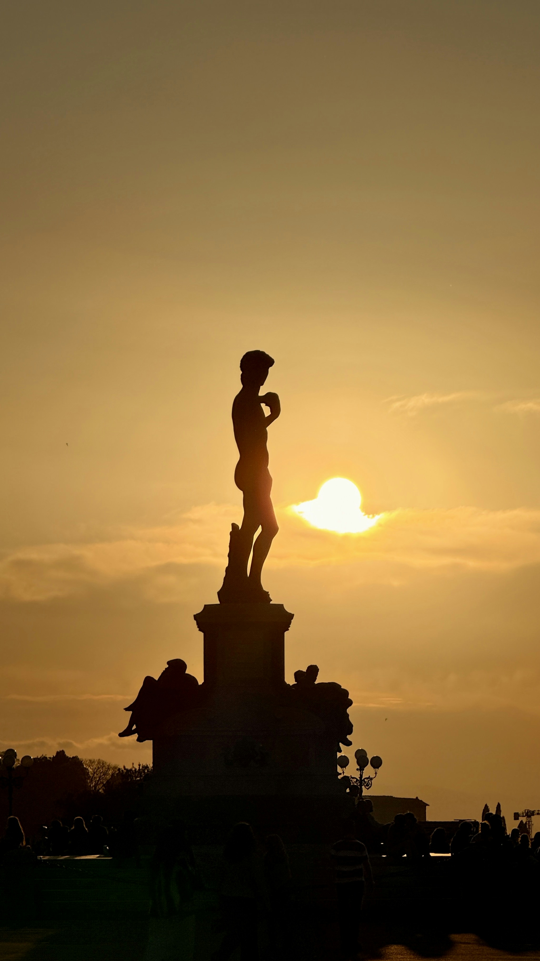 Sunlit Sentinel: A Statue Silhouette at Dusk