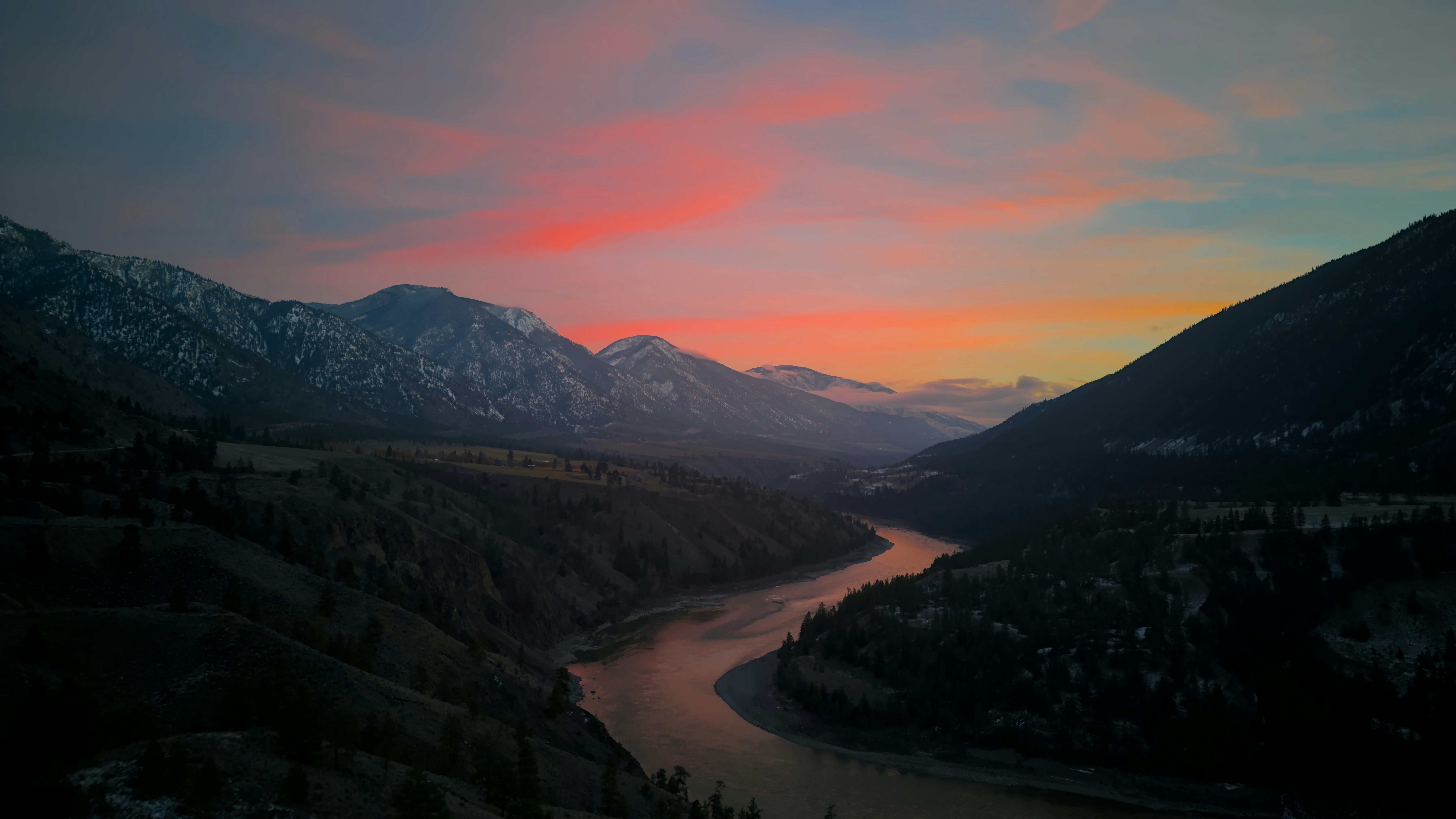 Twilight Currents: A Valley Sunset Embraces a Winding River