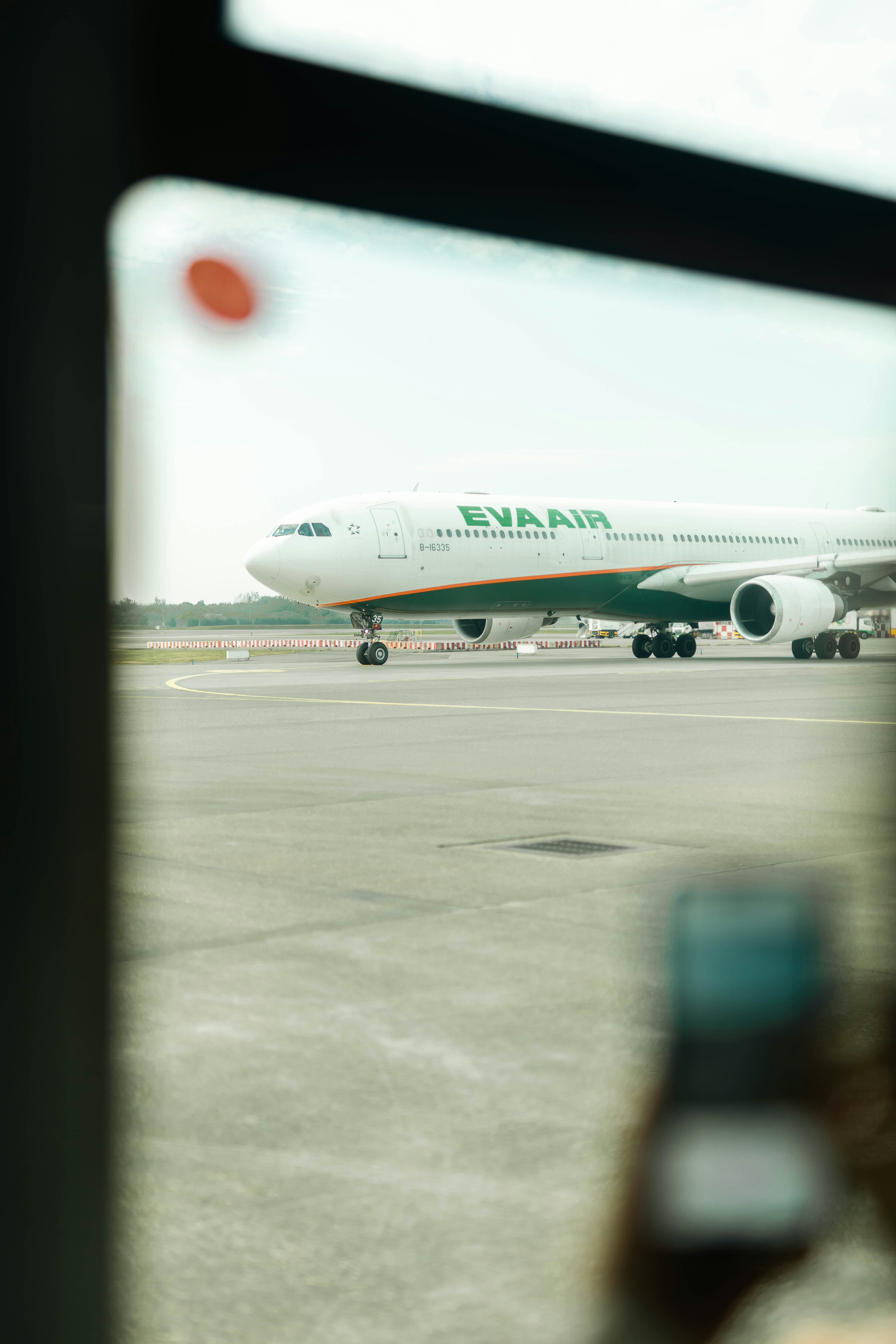 Nose-Forward on the Tarmac: EVA Air Framed by a Window View