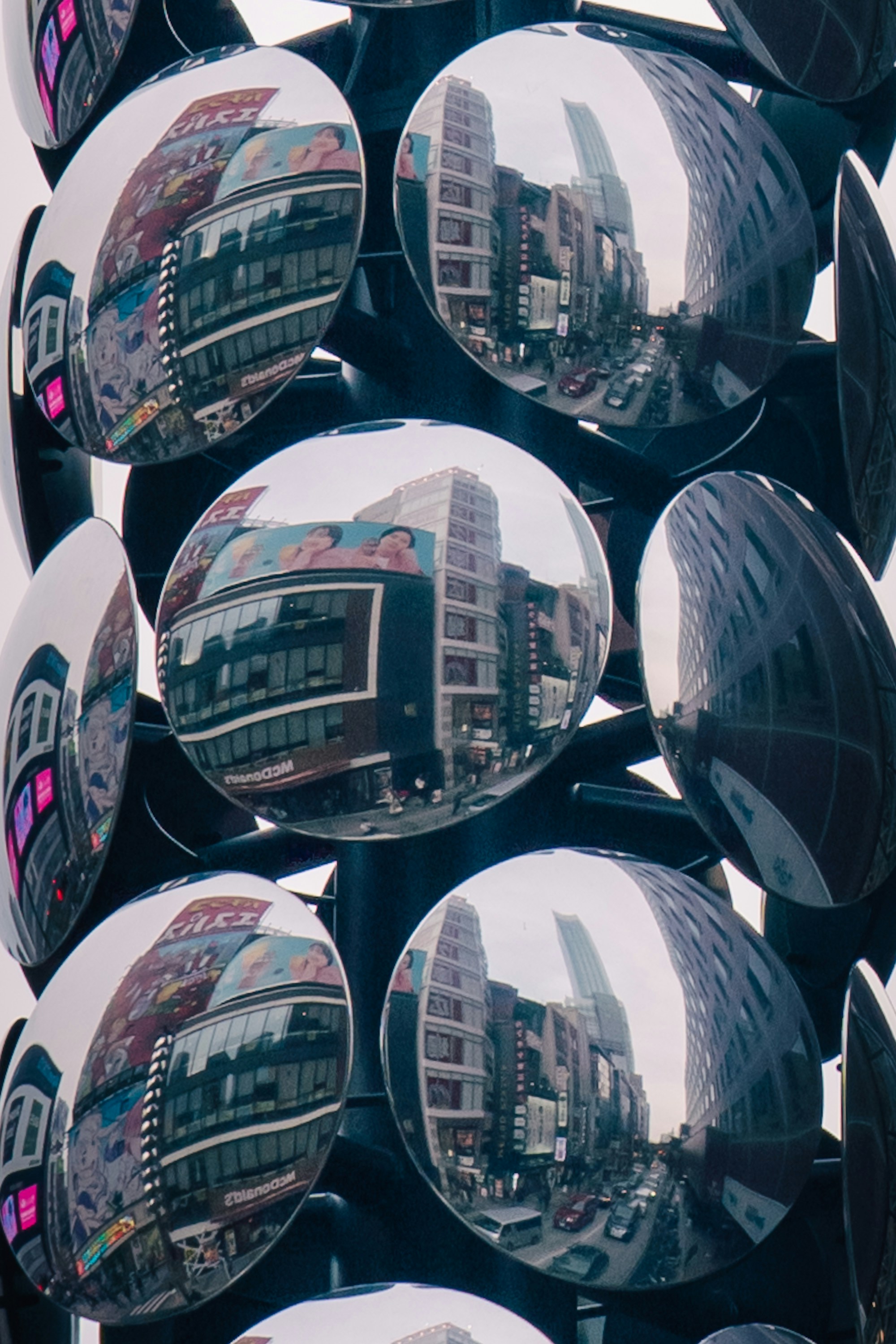 City Reflections: A Choir of Chrome Orbs in Motion
