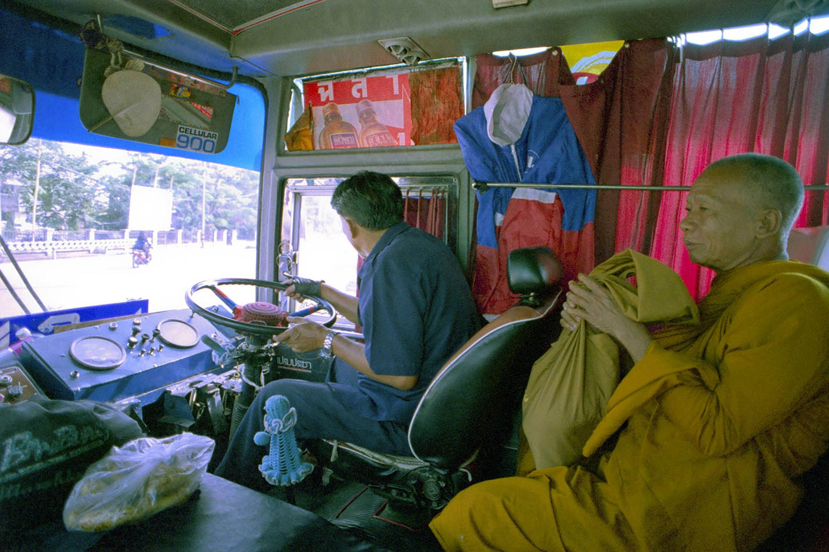 A bus driver and a monk ride together. photo – Free Man Image on Unsplash
