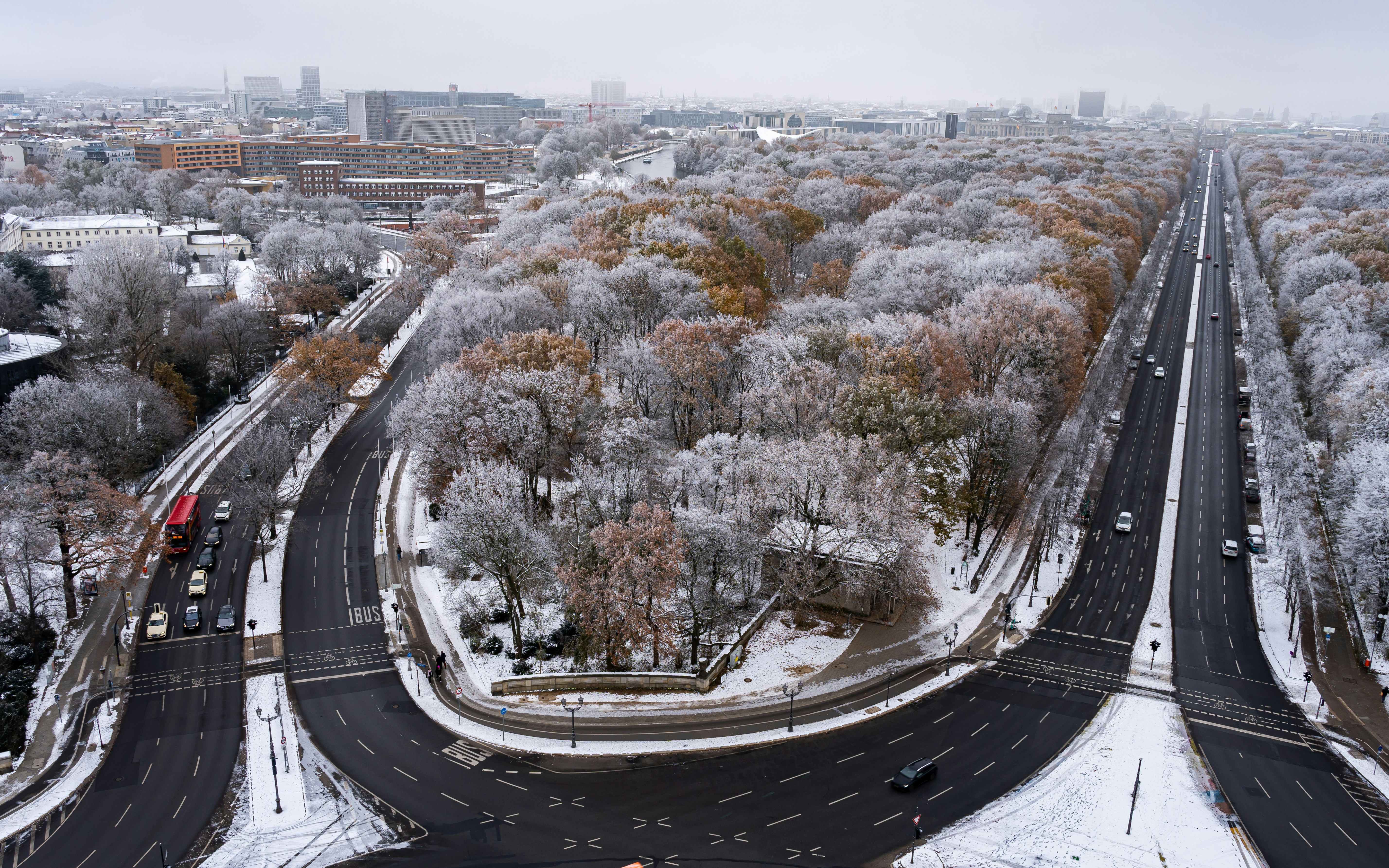 Frosted Ring: An aerial view of a snow-dusted roundabout framed by winter trees