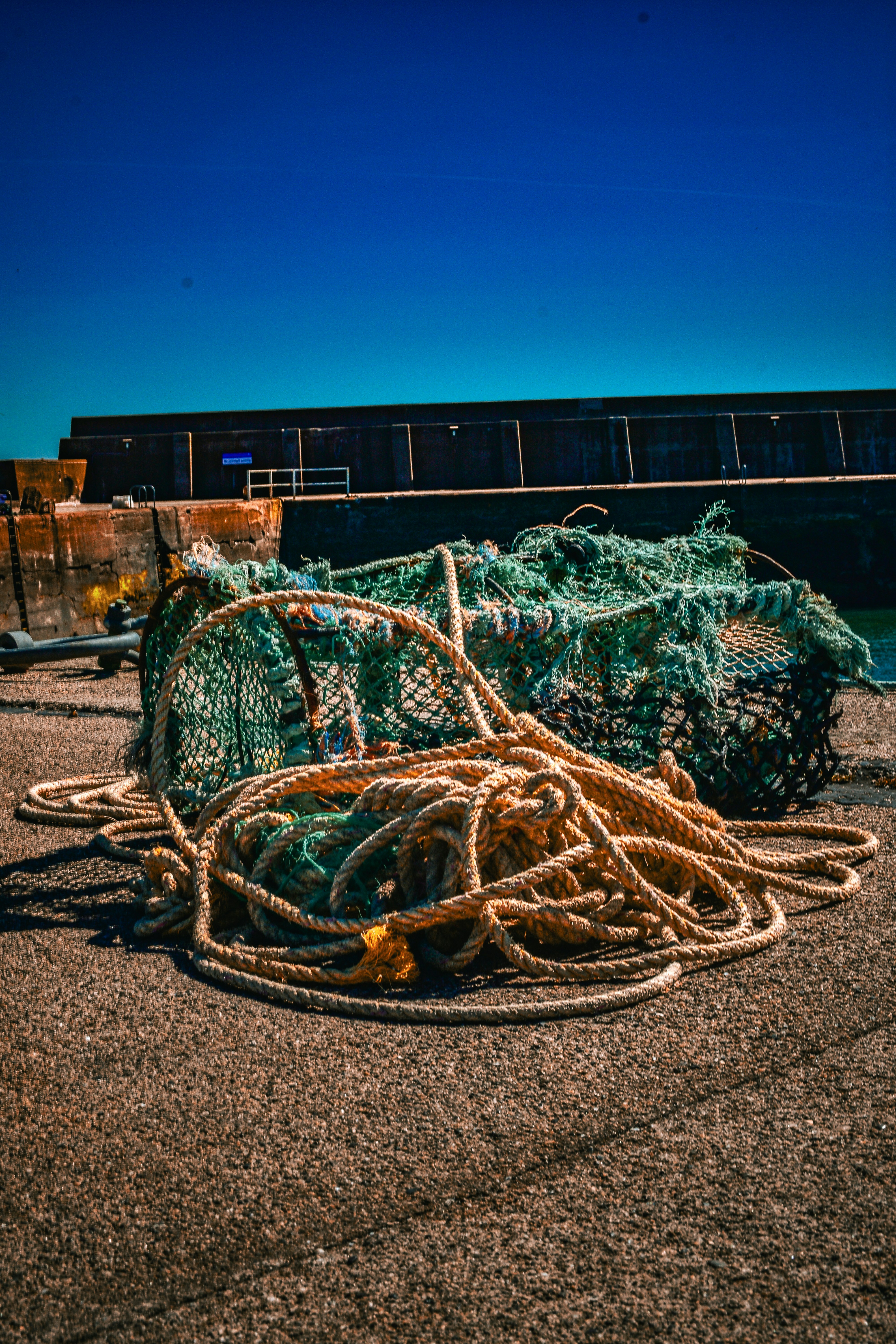 Crab Trap at Stonehaven harbour | Fishing nets and ropes sit on a pier.