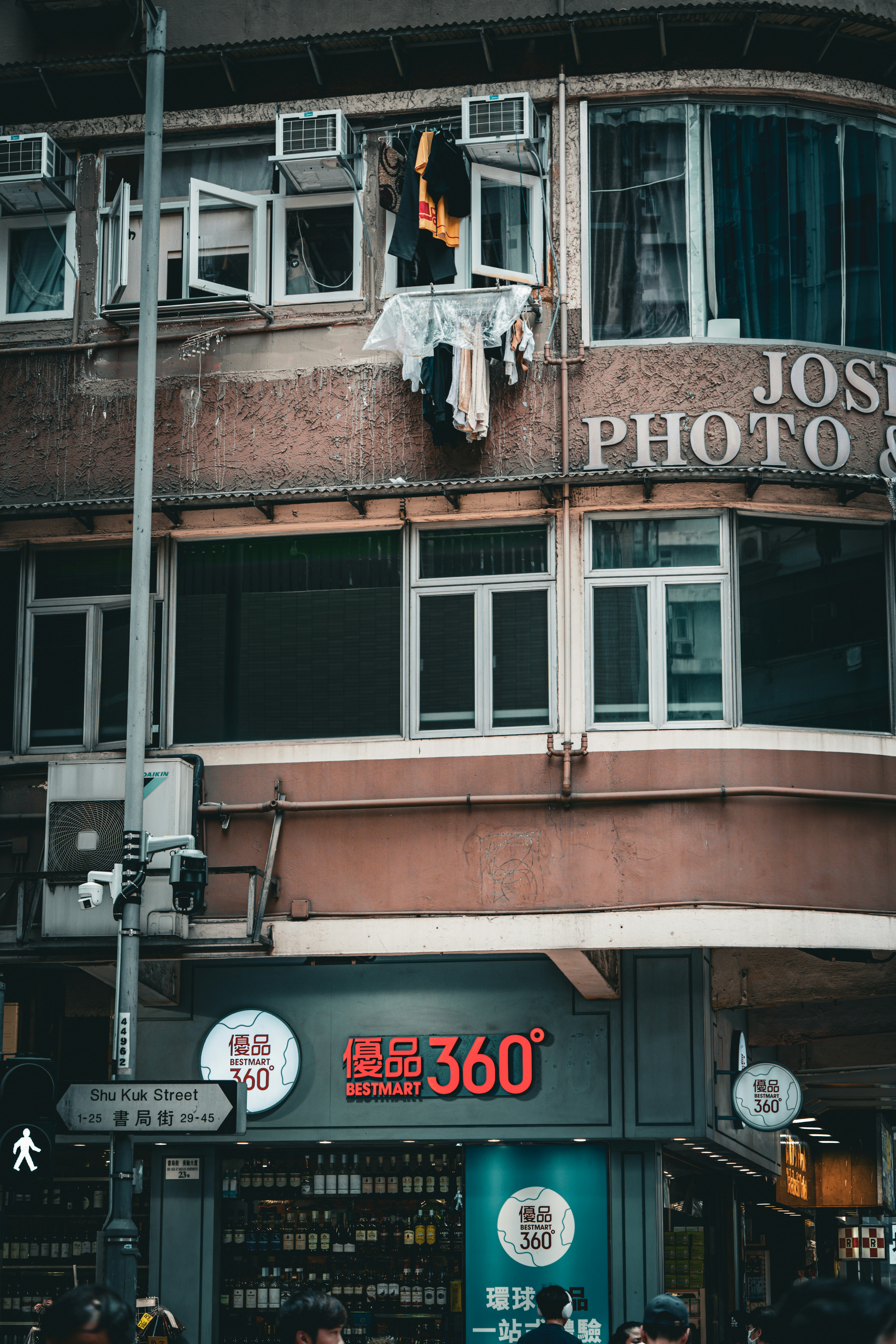 Clothesline Above the City: Laundry Draped Over a Weathered Shopfront