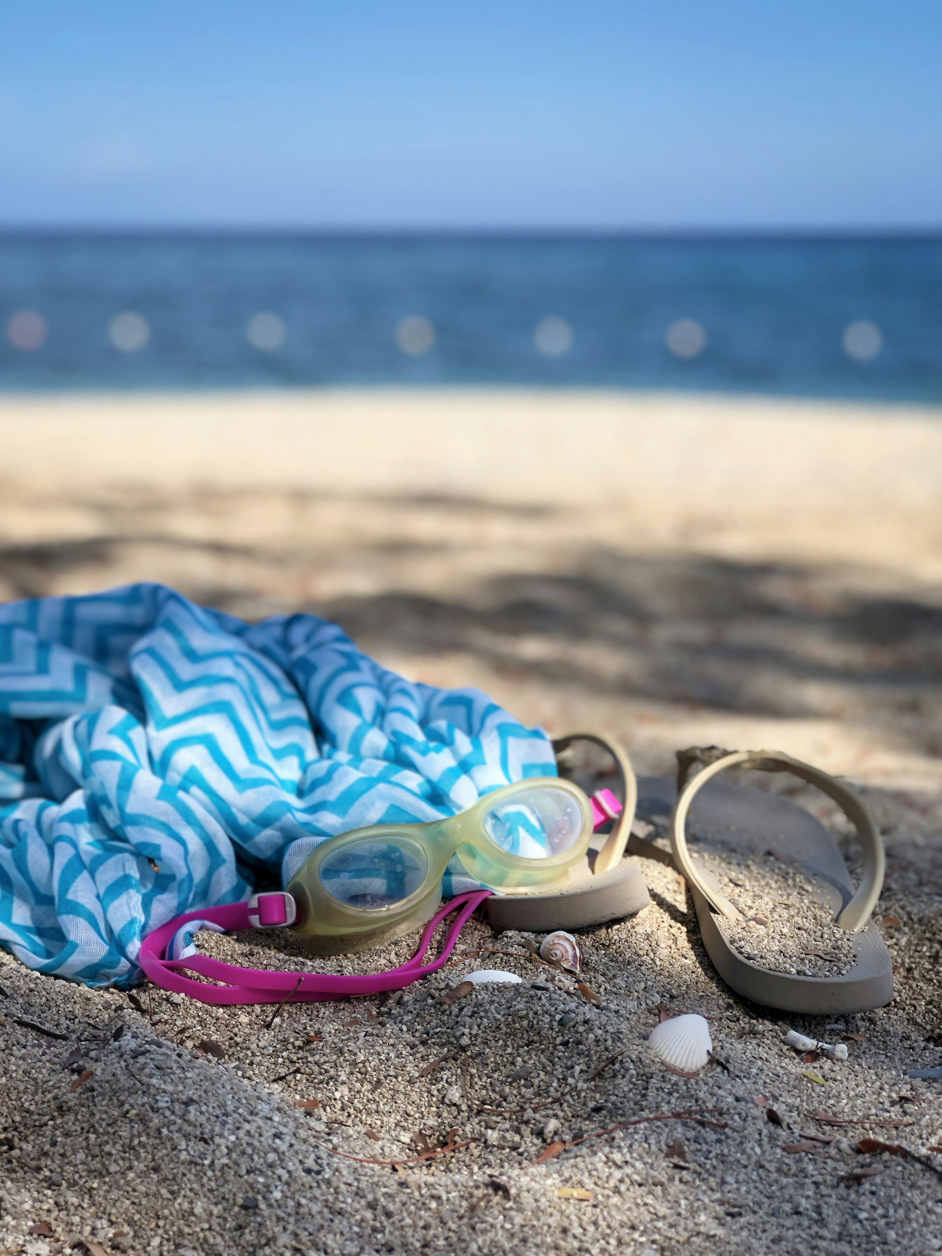 Goggles, Zigzag Fabric and a Sand-Wedged Shell: A Quiet Beach Still Life