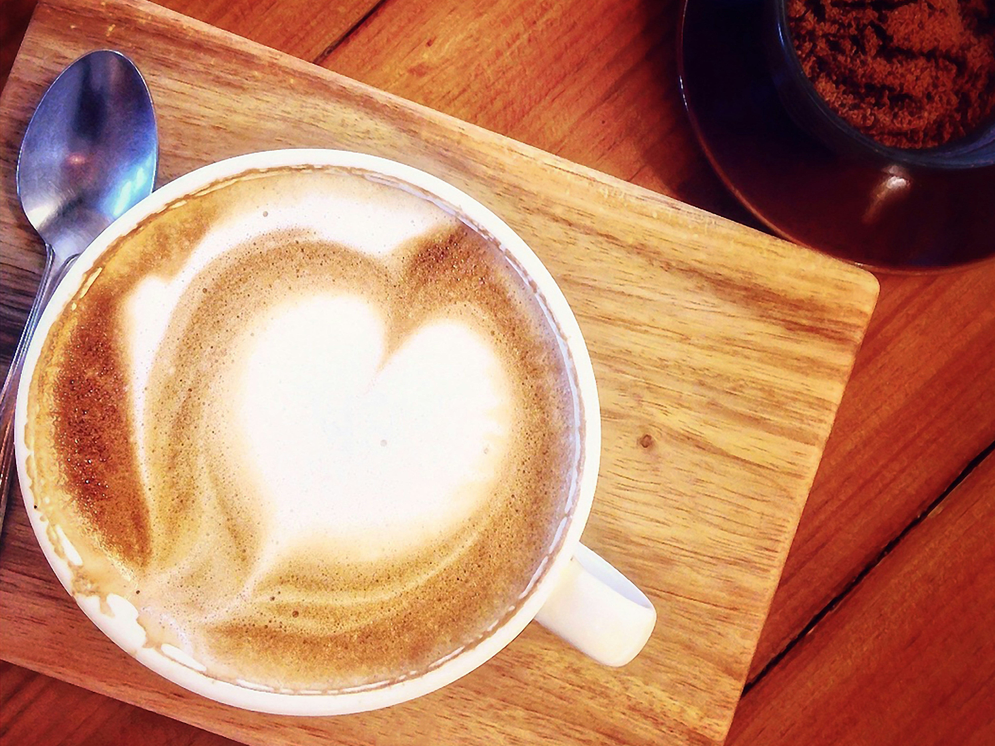 Heart-shaped latte art in a coffee cup. photo – Free Coffee Image on ...