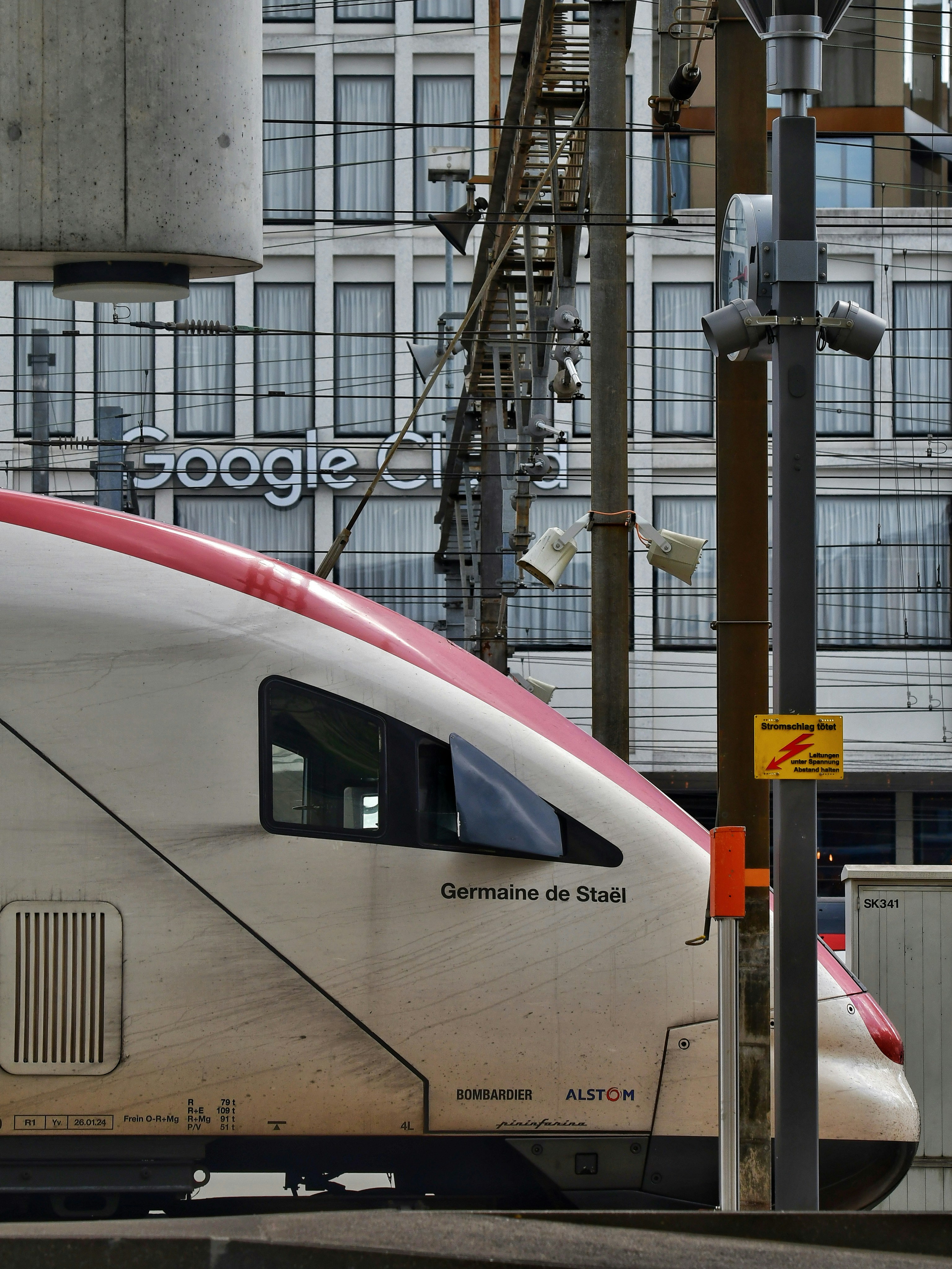 Aurora Express: A Leaning Train Quietly In Front of Google HQ Facade
