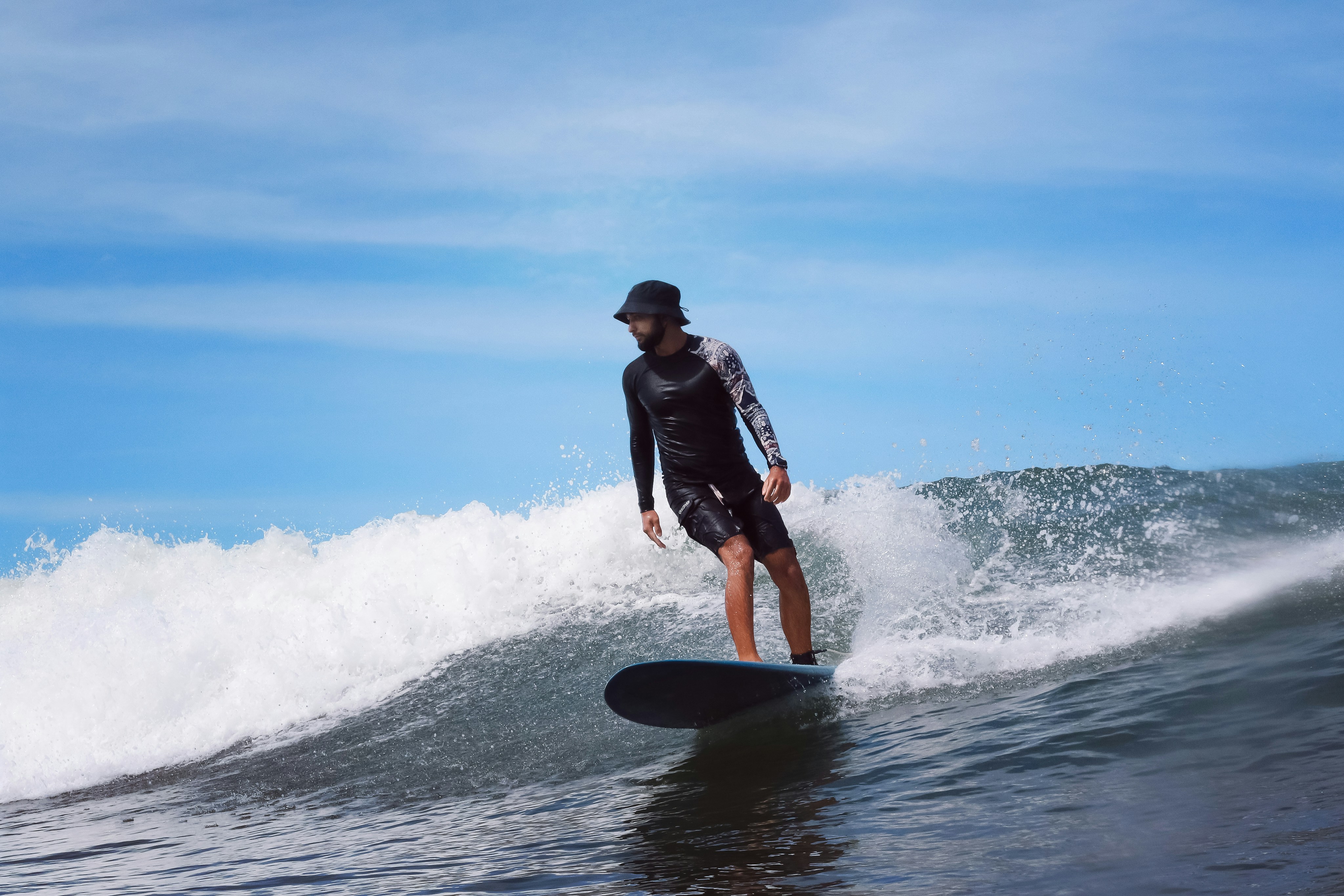 Glide on the Crest: Surfer Balances on a Quiet Pacific Break