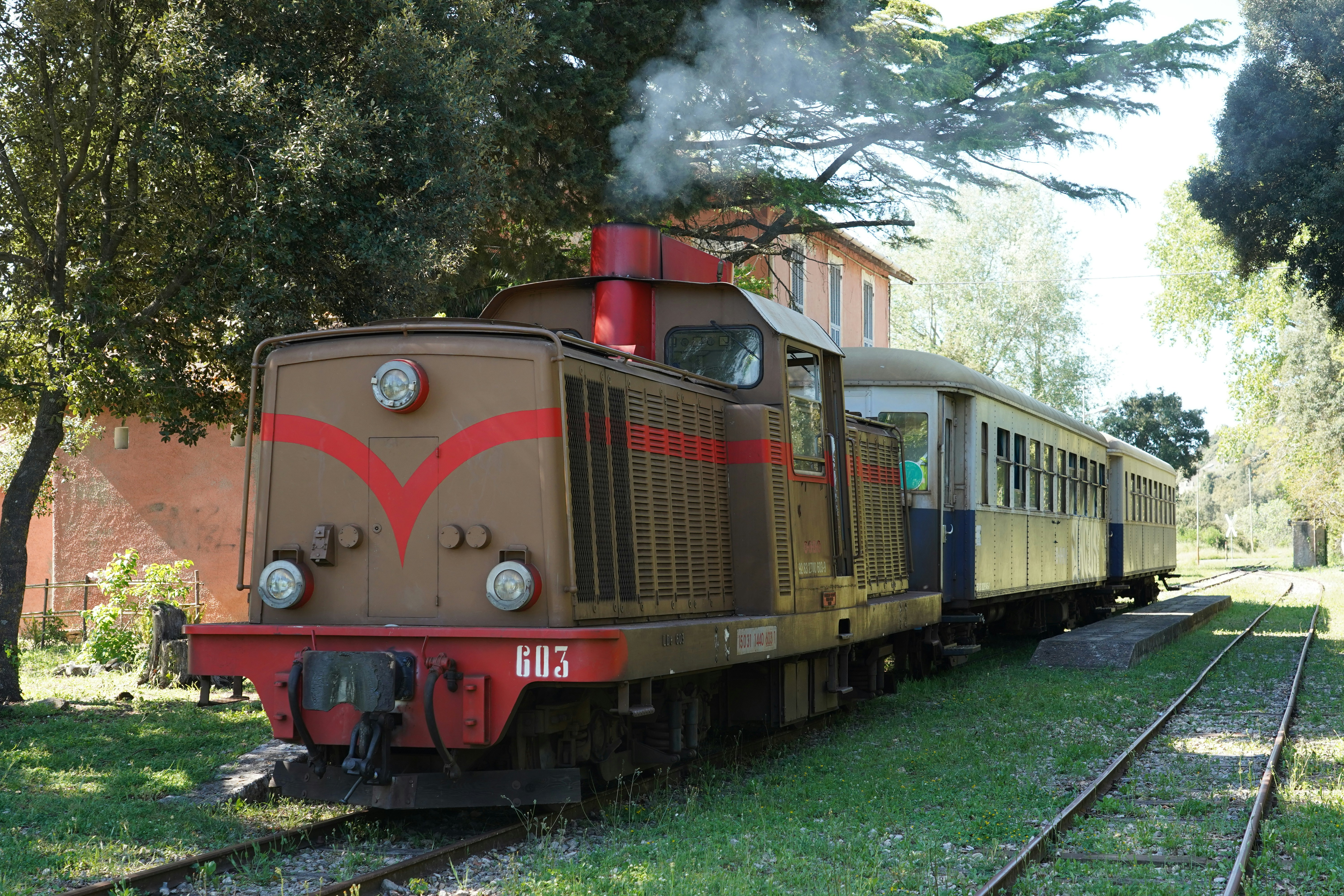 Heritage Steam Engine Resting Along a Sunlit Parkside Track