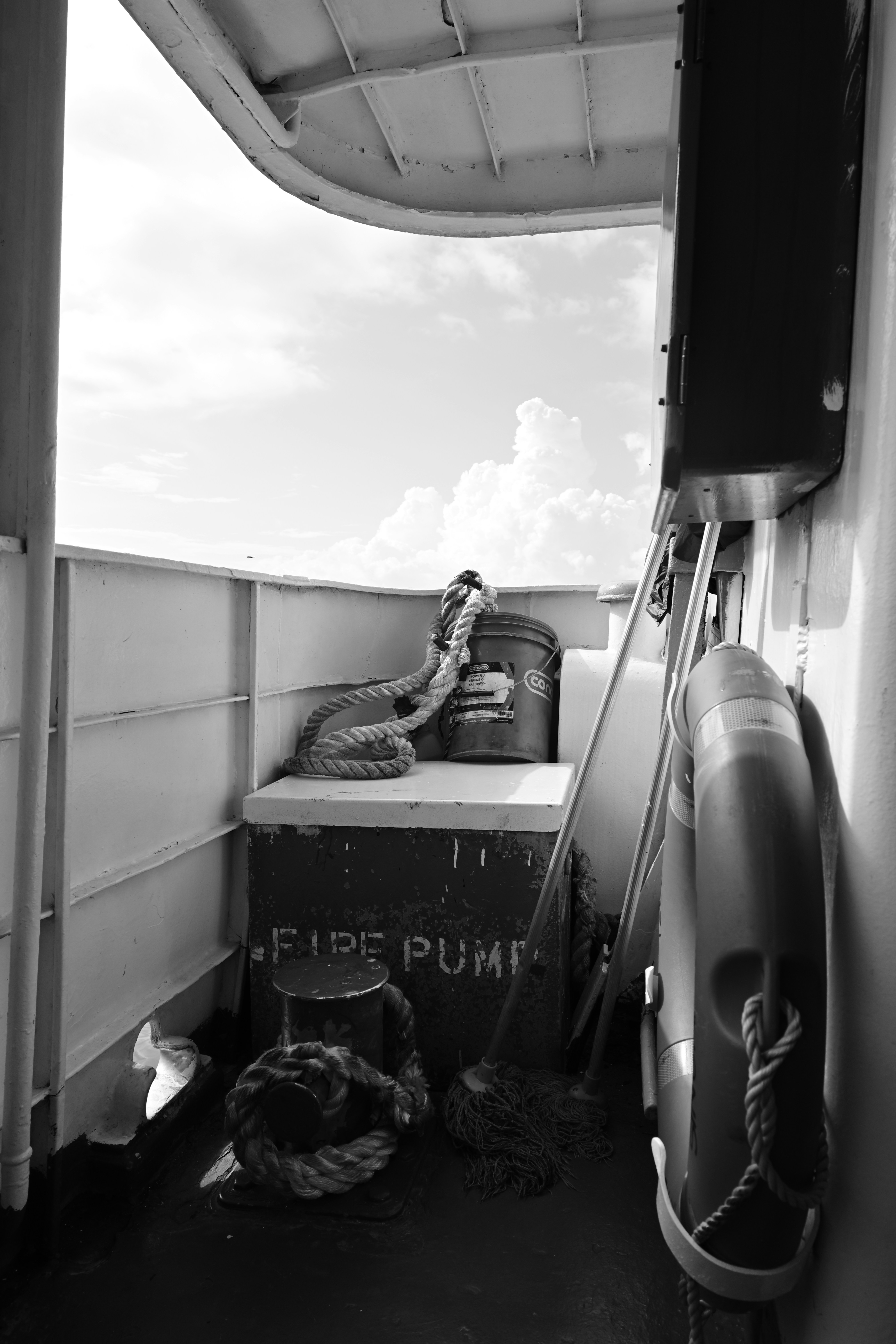 Rope Coil at the Edge: A Monochrome Ship Deck Portrait