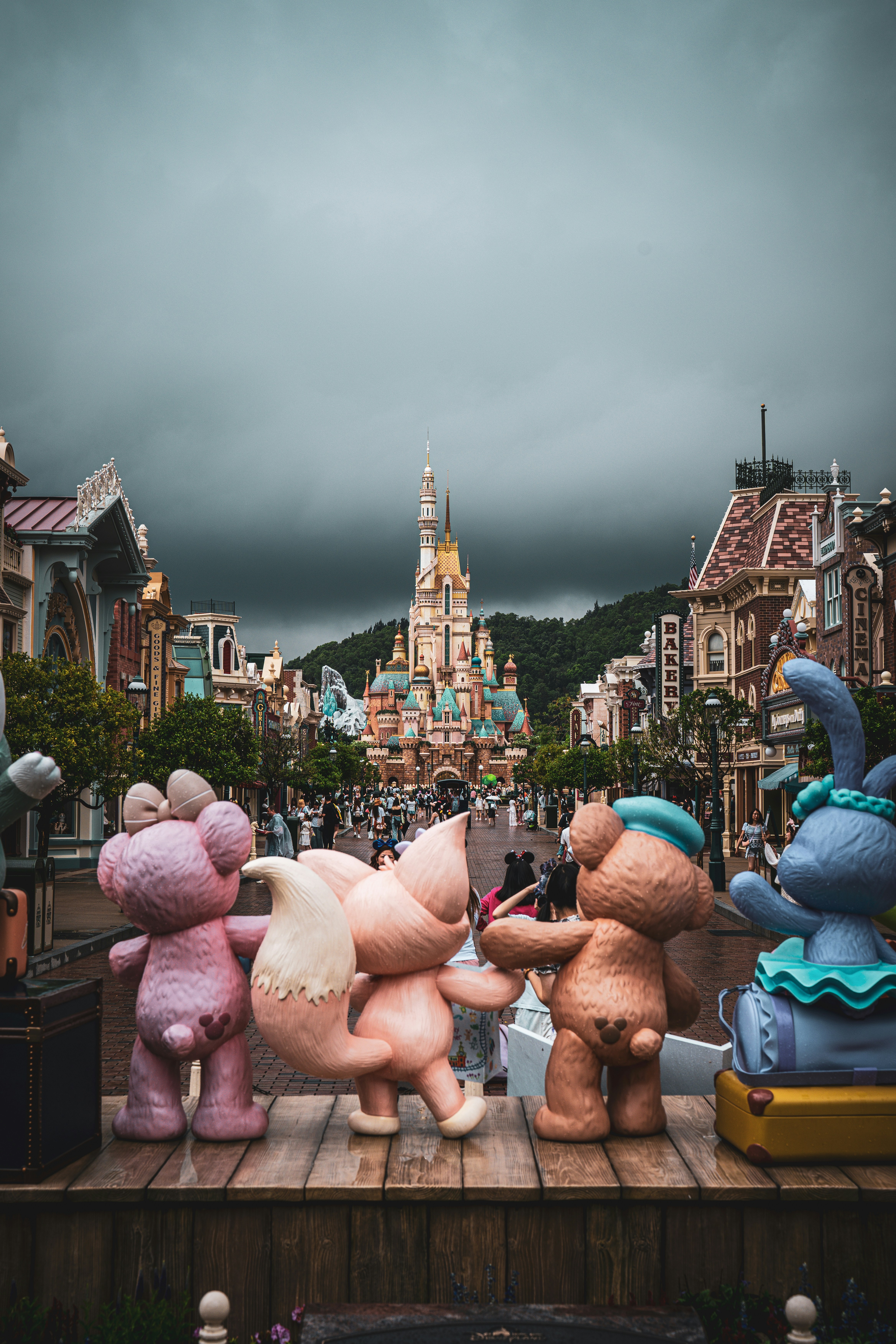 Disney characters pose in front of a castle. photo – Free Man Image on ...