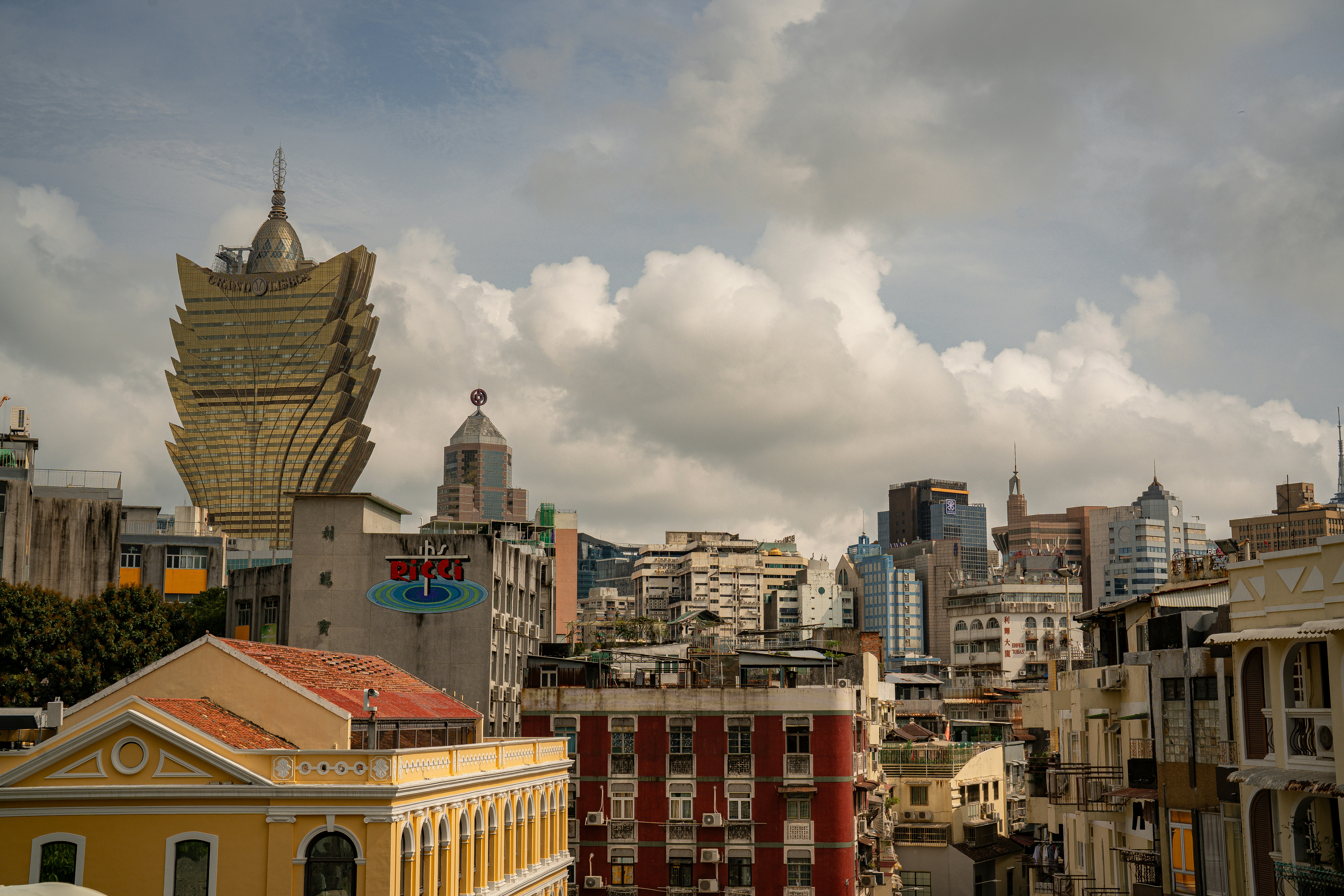 Cityscape Crown: The Golden Structure Above a Tapestry of Rooftops