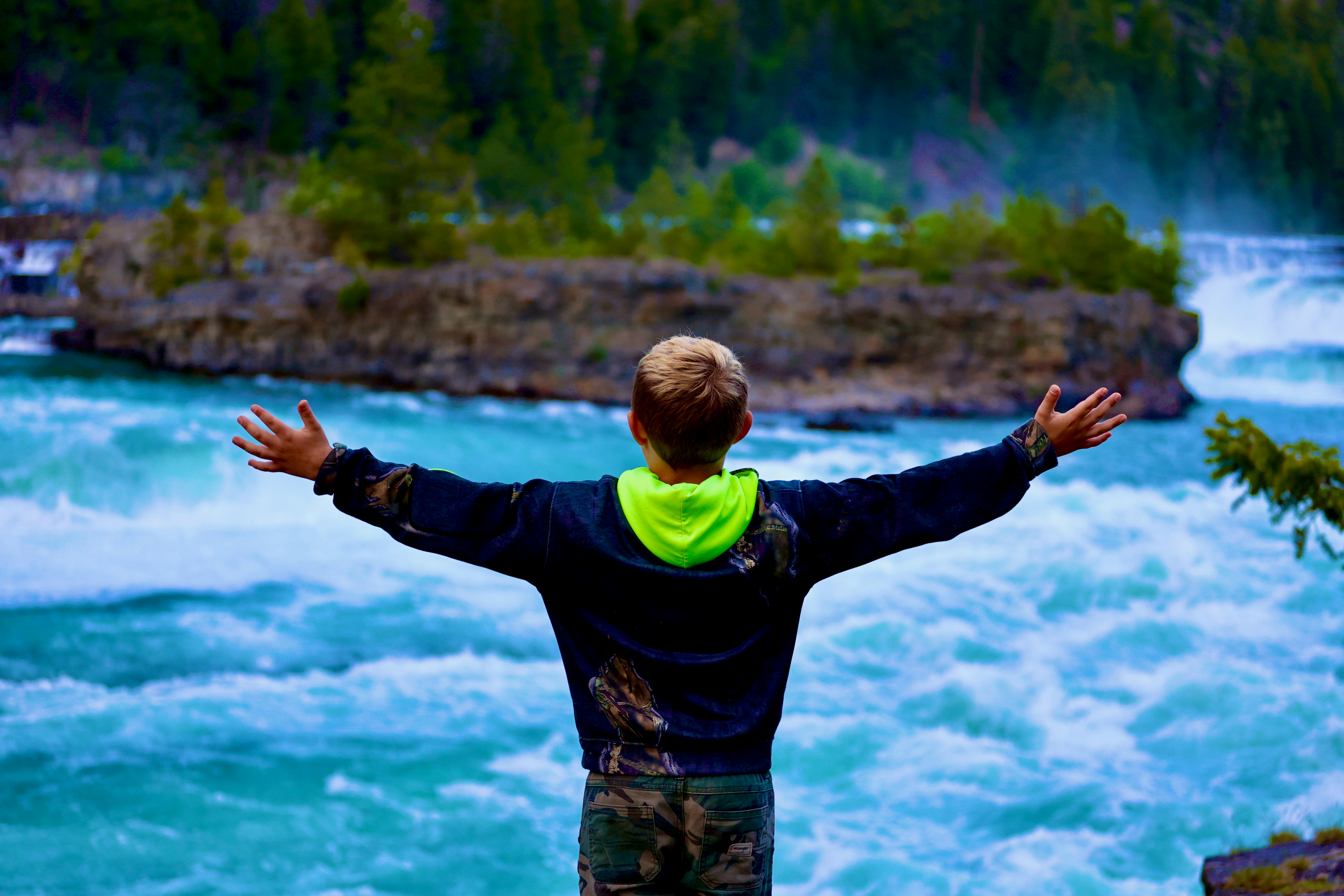 Arms Wide Over Turquoise Rapids