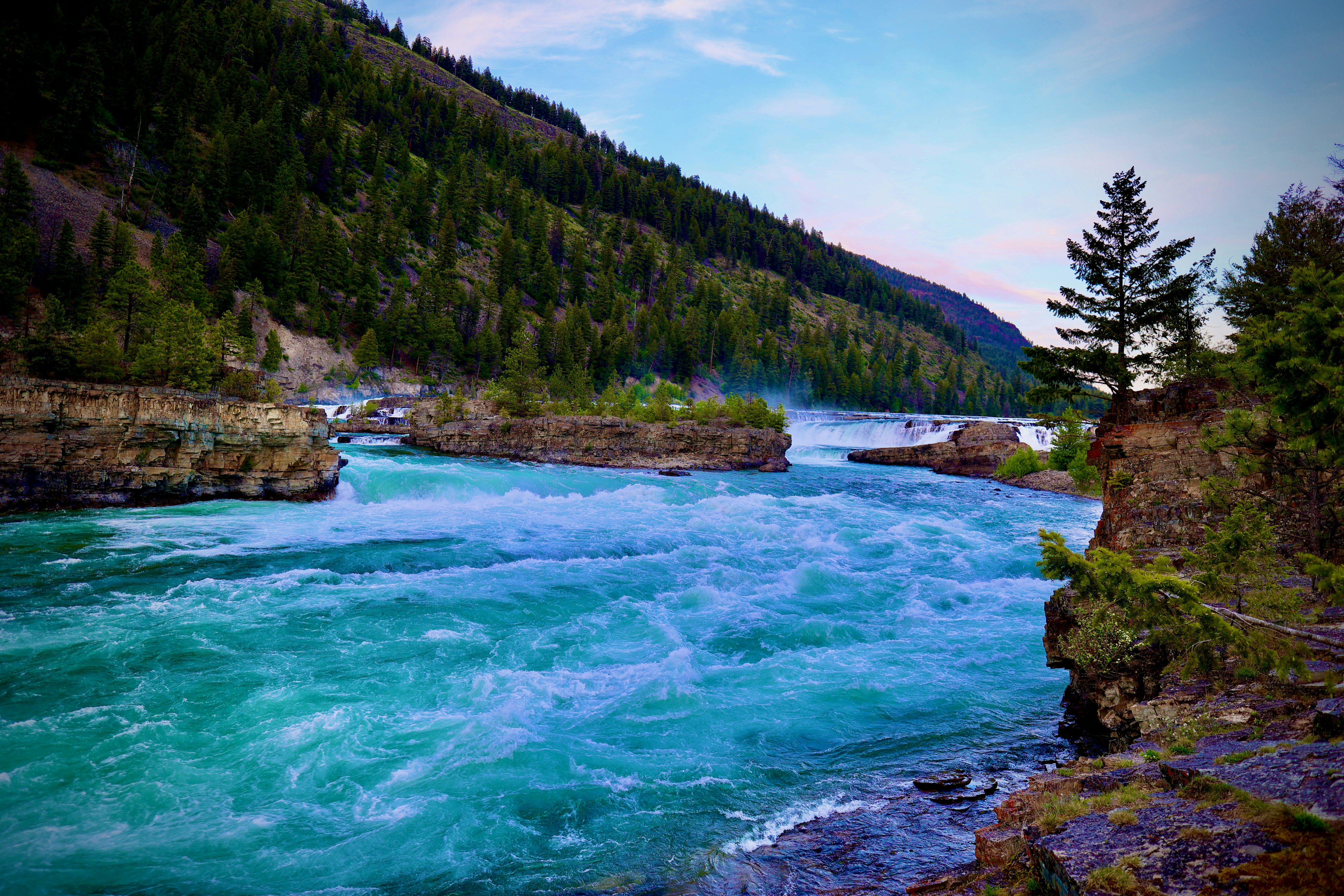 Vibrant turquoise river flows through a lush canyon. photo – Free ...