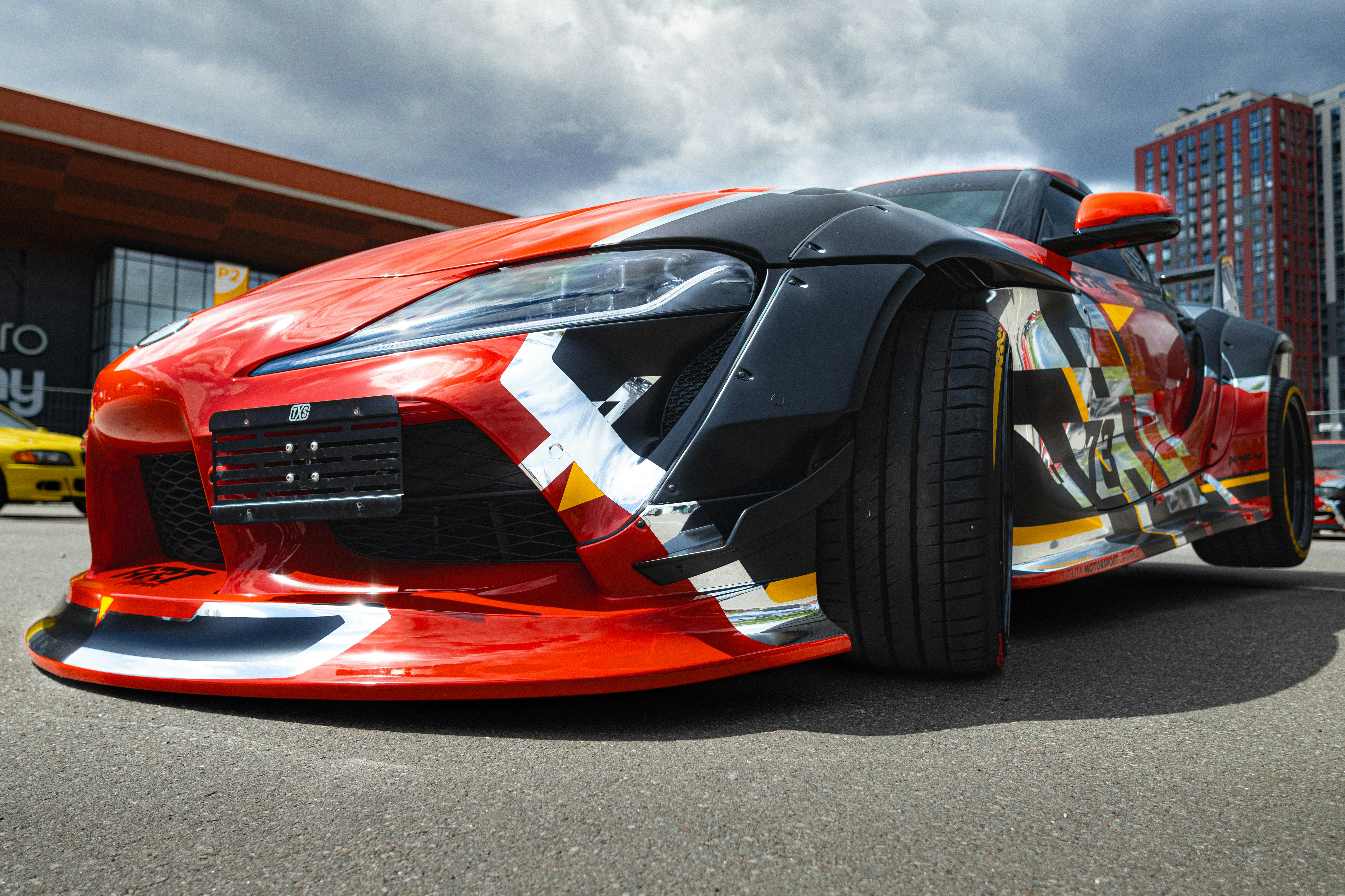 A sporty red and black car is shown. photo – Free Sports car Image on ...