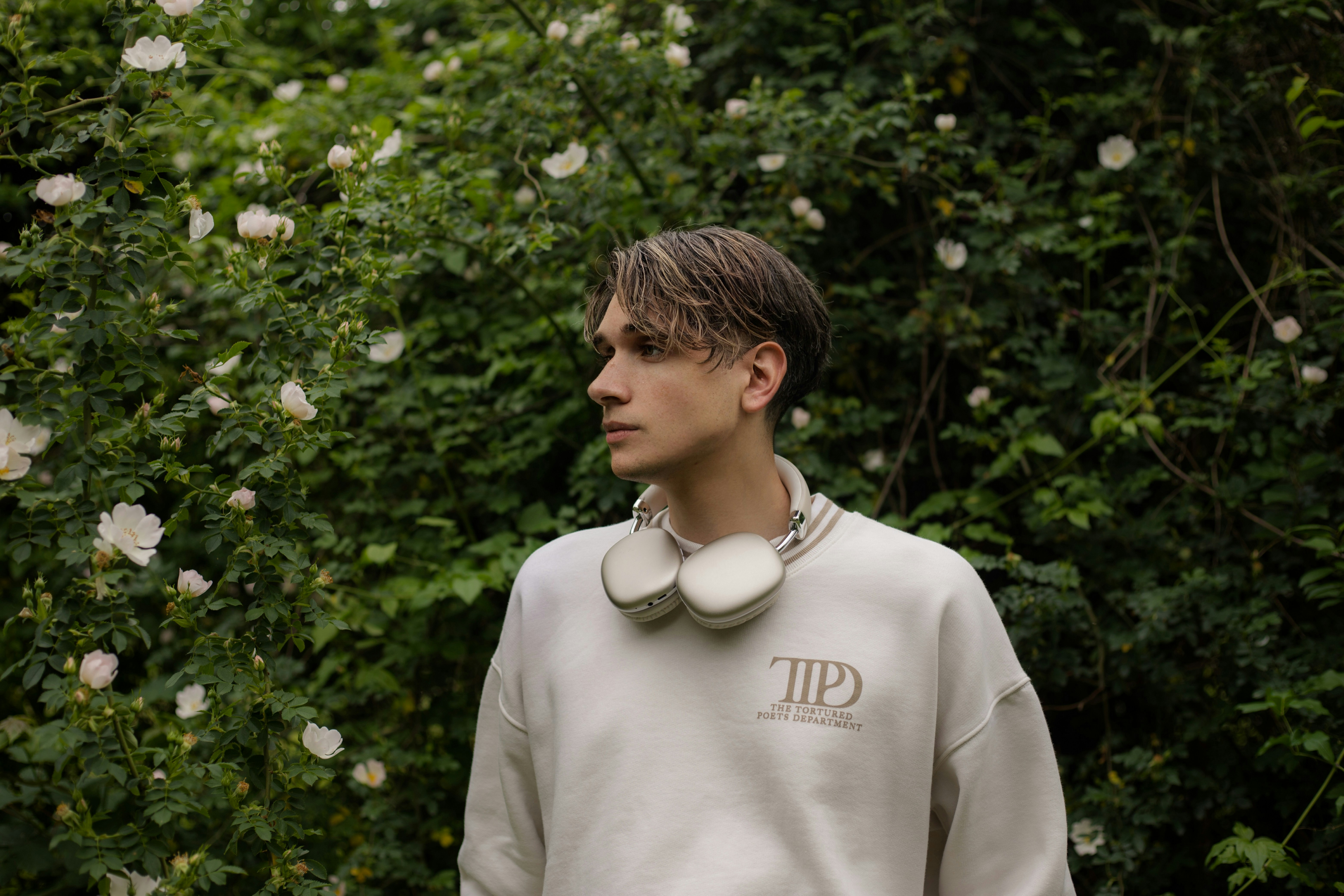 Gaze in the Grove: A Quiet Portrait with Headphones Resting Above Quiet Confidence
