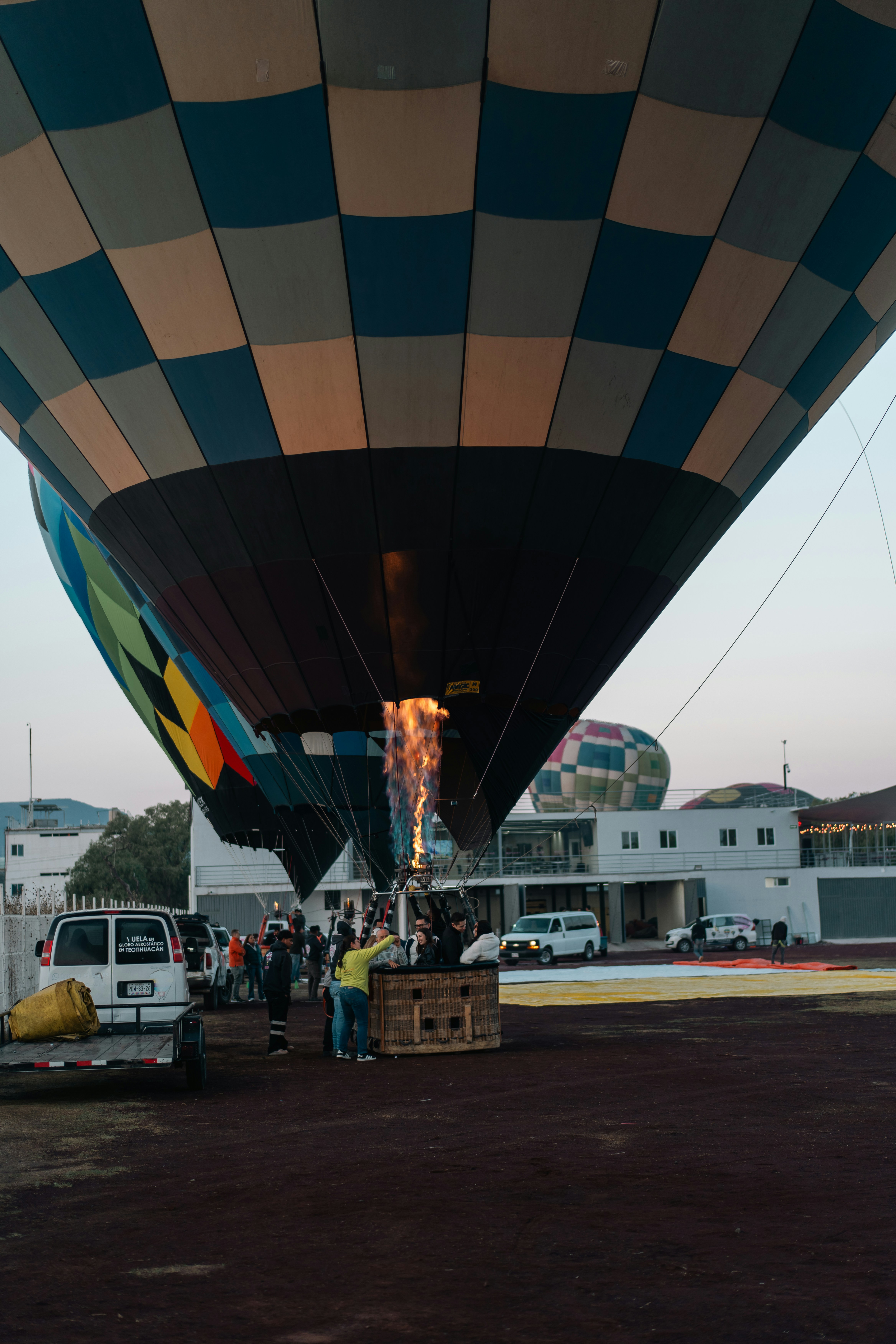 Dusk Flame Over a Checkered Giant: Balloon Inflation