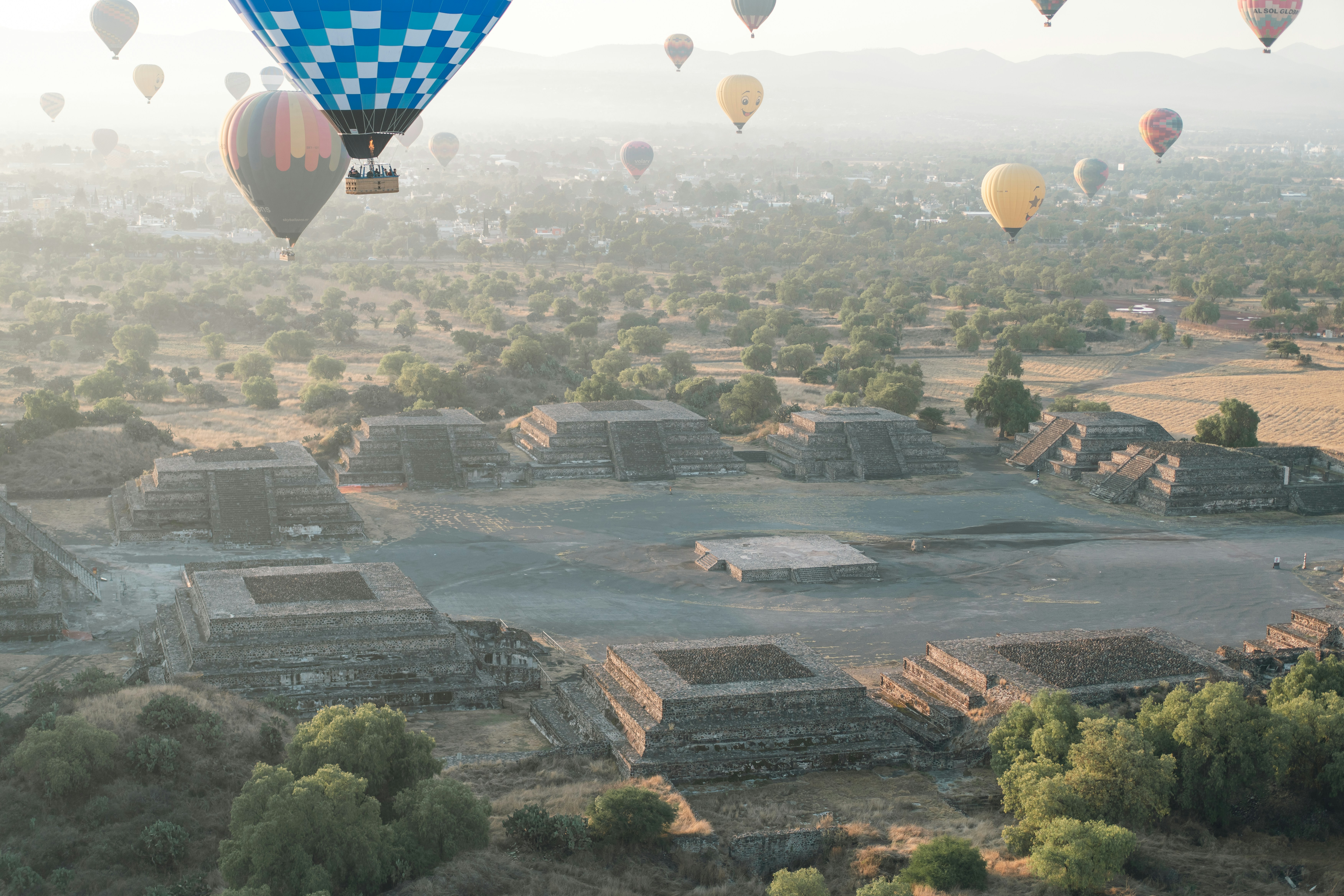 Blue-Checkered Balloon Panorama Over Ancient Terraces at Dawn