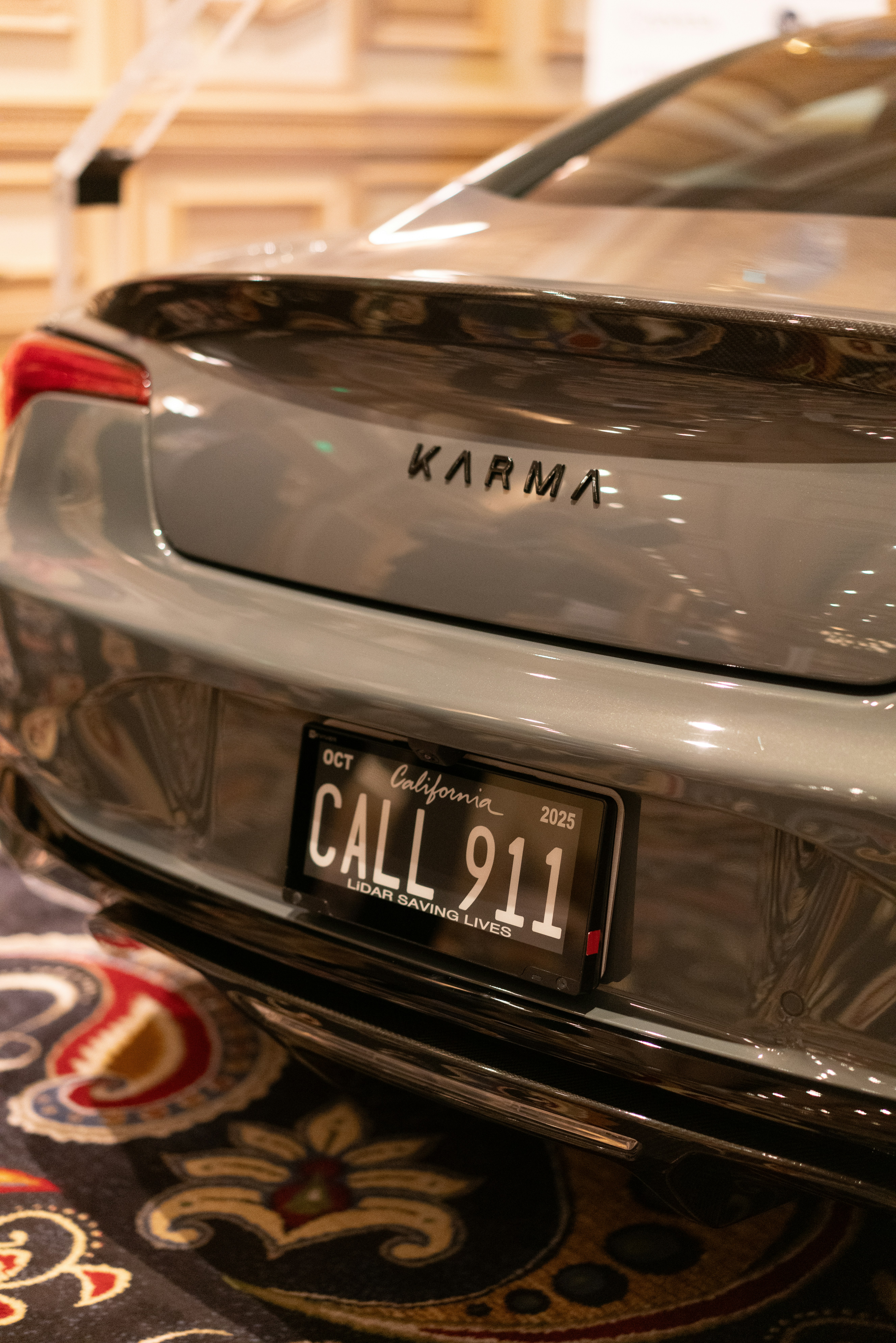 A gray karma car with a "call 911" license plate. photo – Free Car ...