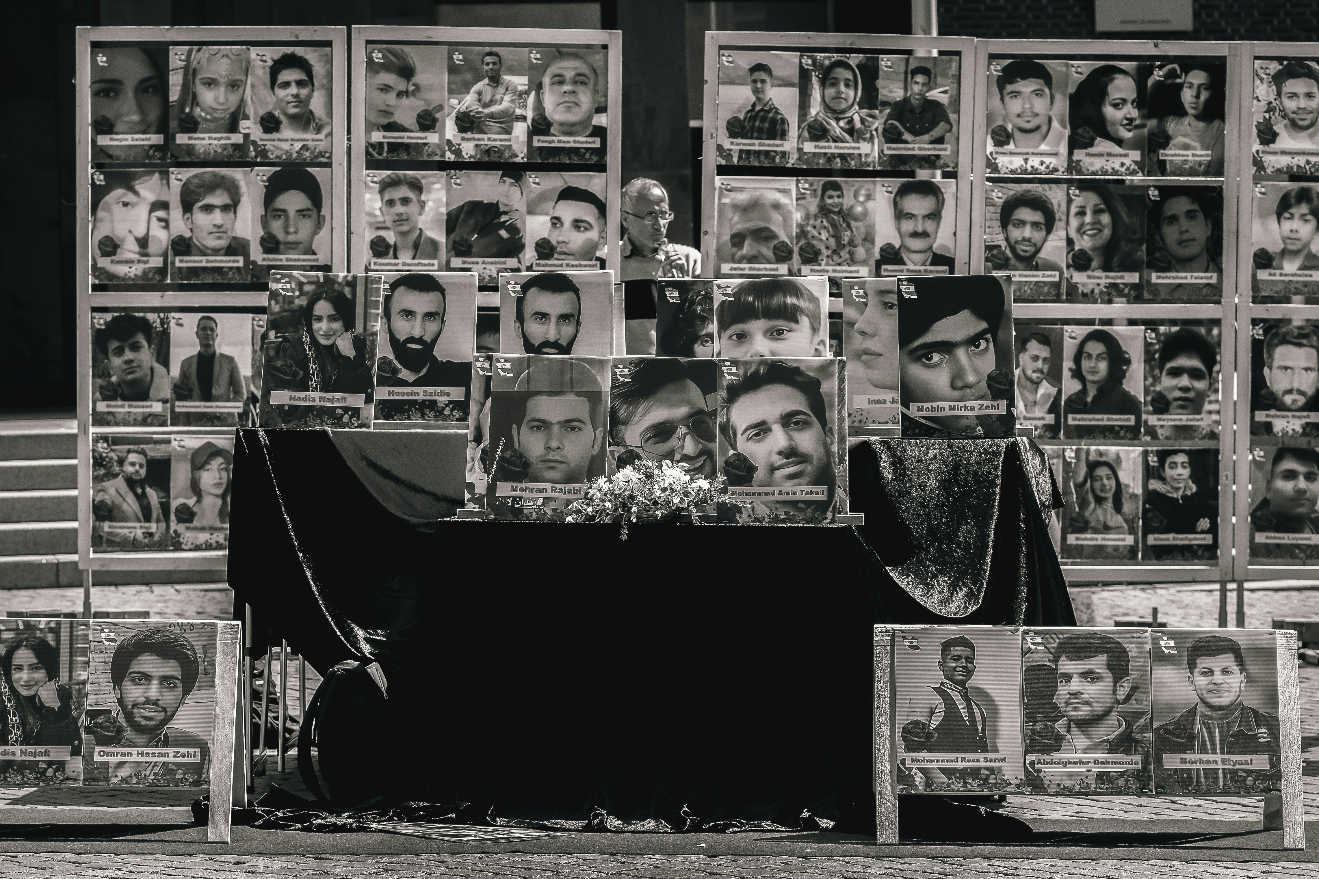 Portraits of lost lives displayed for remembrance.