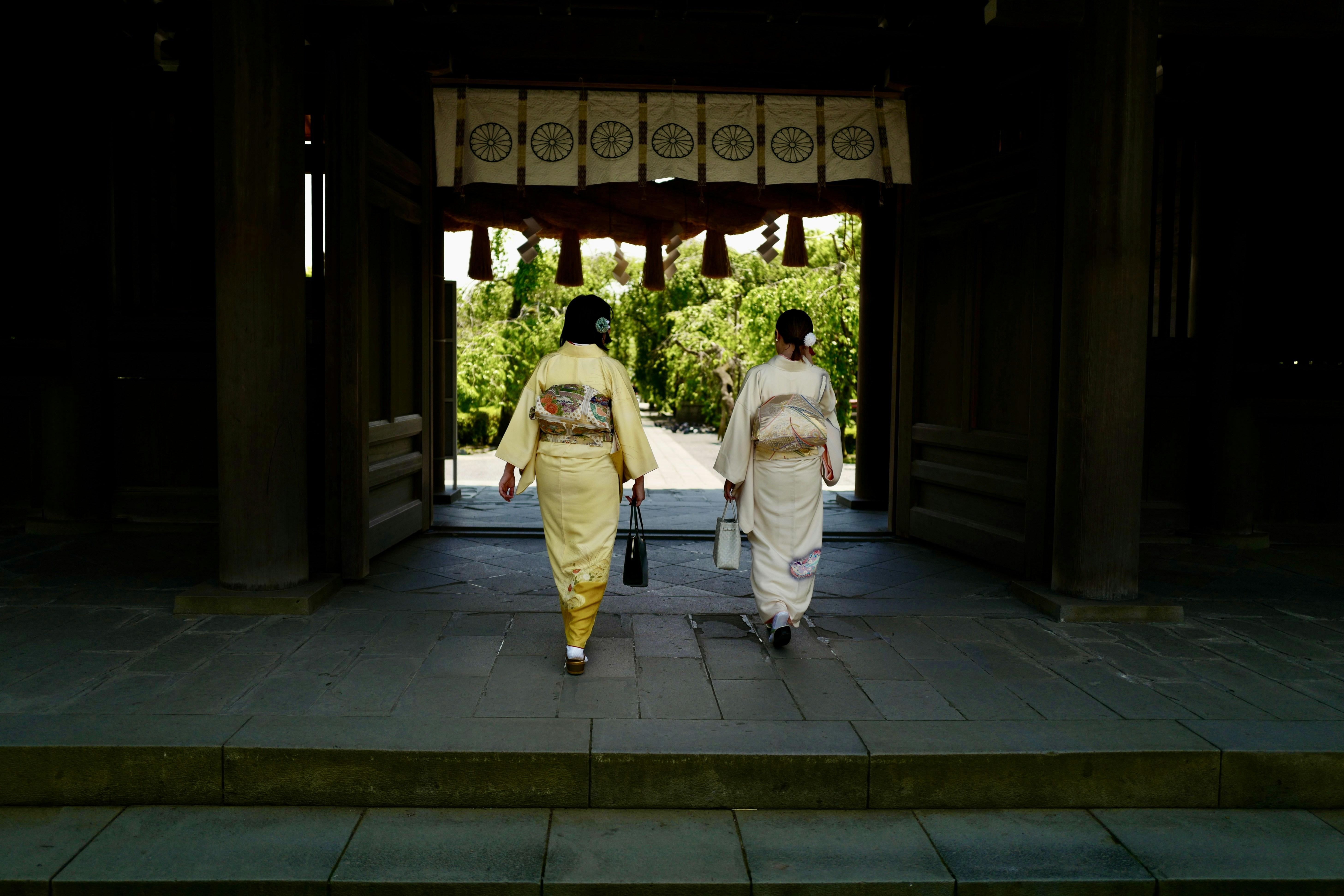 Two women walk through a traditional japanese entrance. photo – Free ...