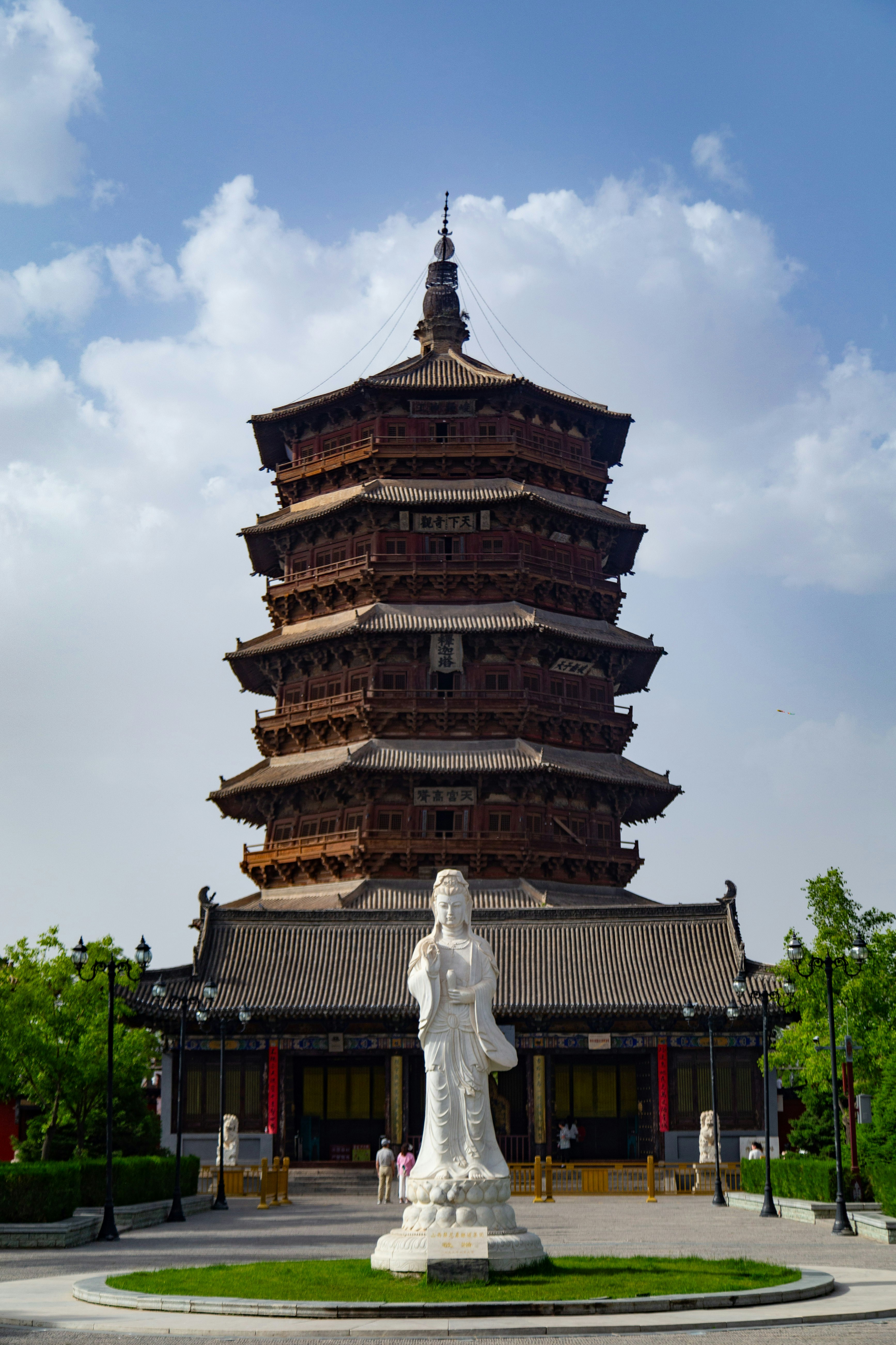 Five-Tiered Silence: A Central Pagoda Framed by a Tranquil Statue