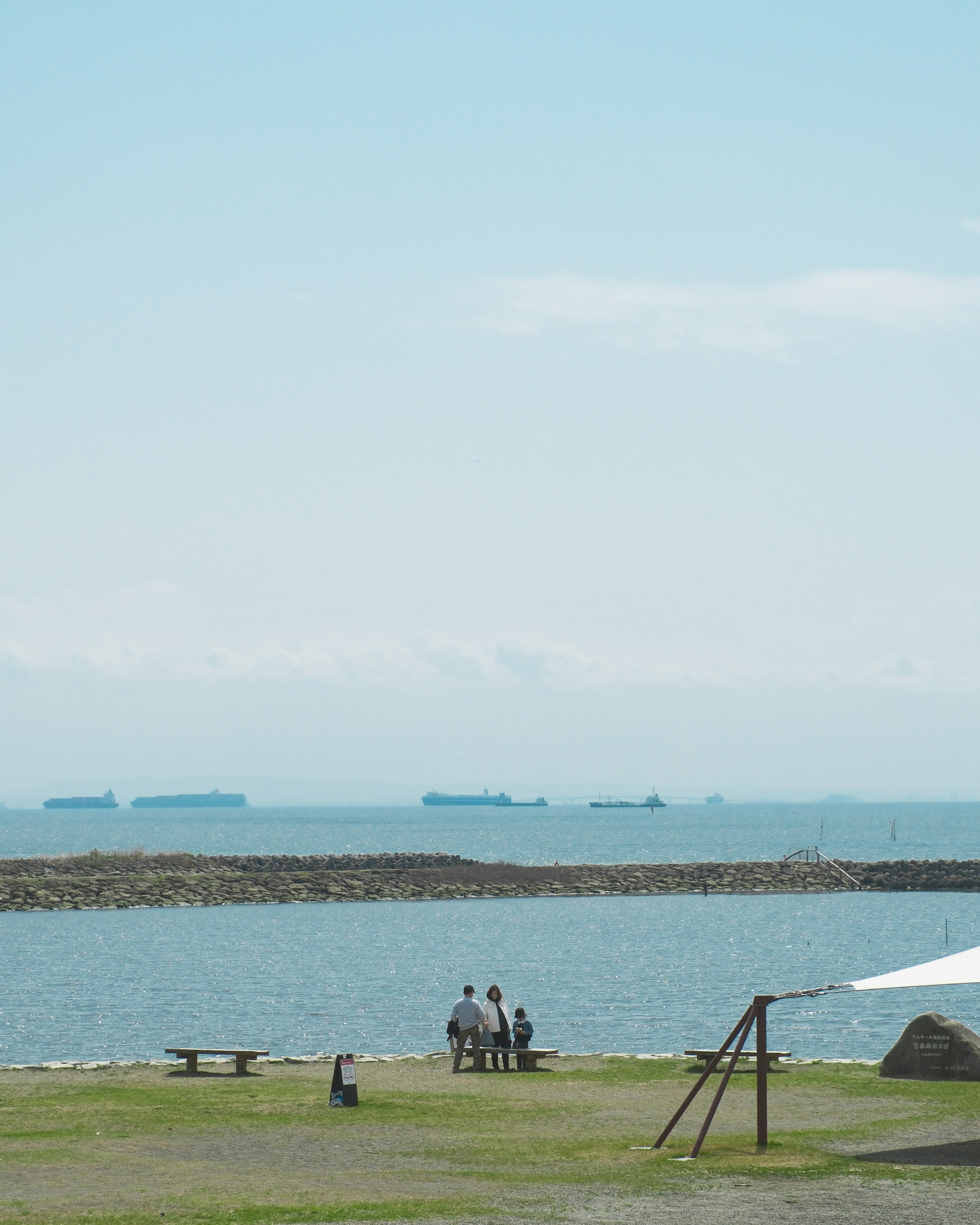 People stand by the water, gazing at ships. photo – Free Japan Image on ...